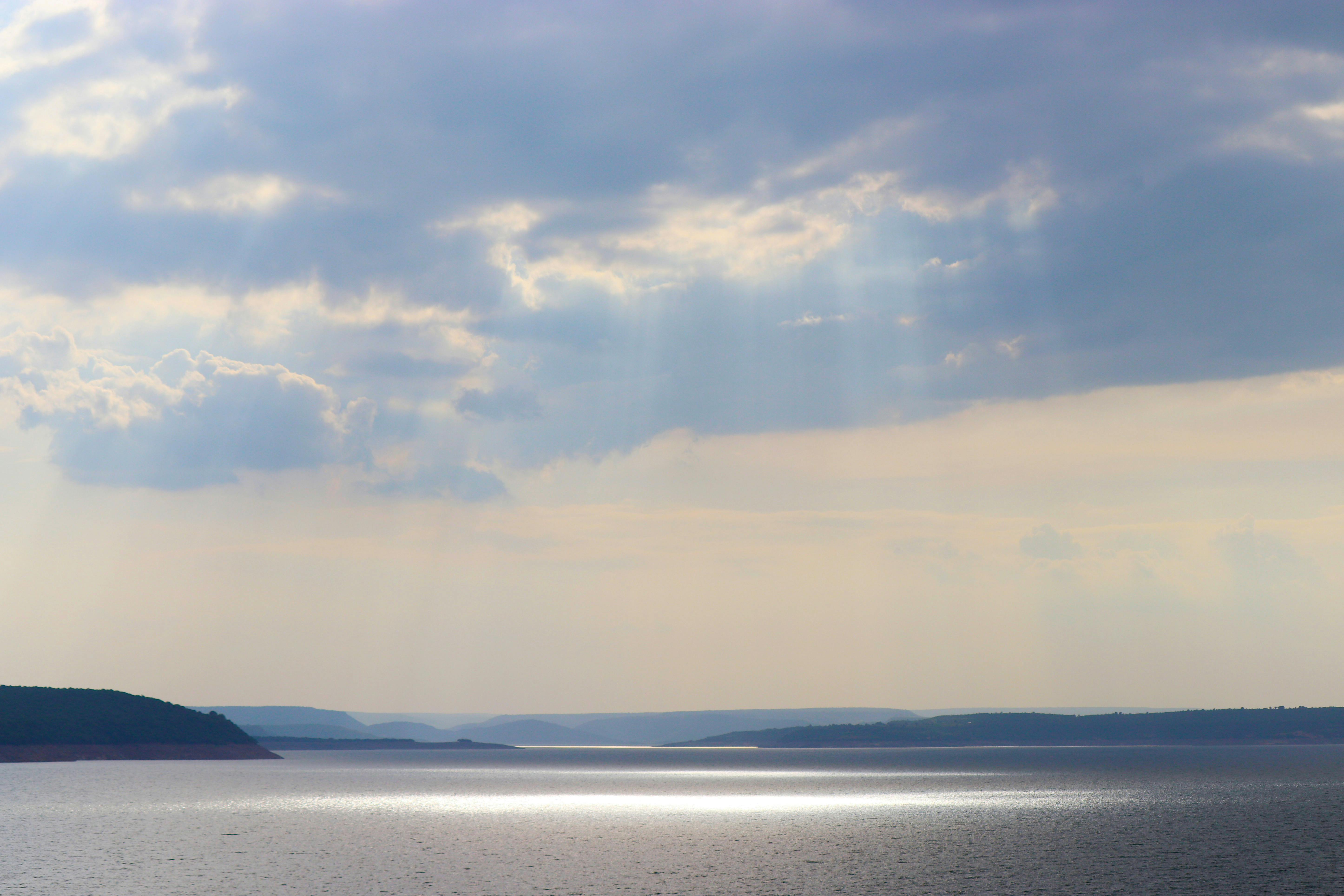 Crepuscular Rays Shining through Clouds on a Water Surface · Free Stock ...