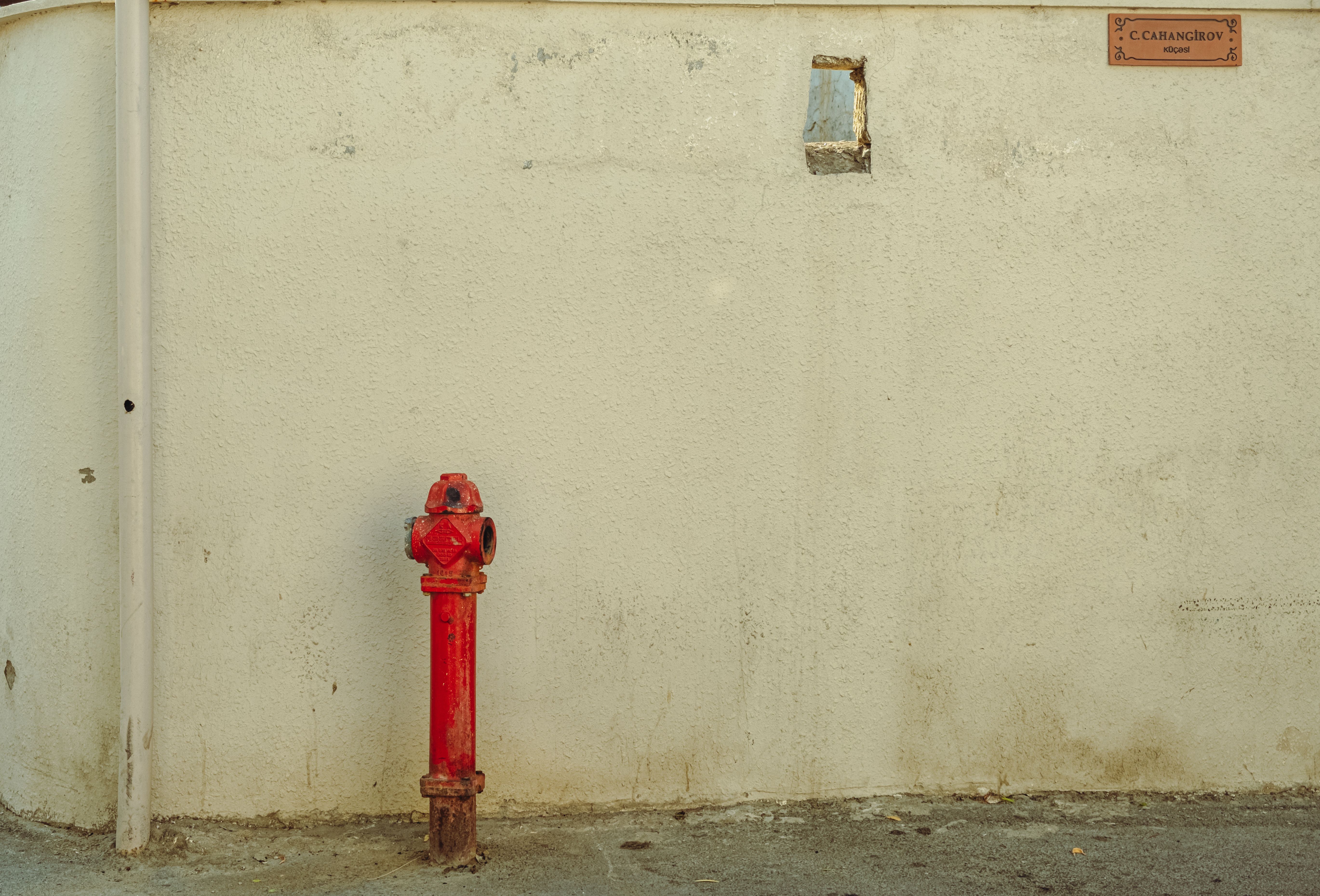 Gray Haired Man Stepping on a Yellow Fire Hydrant · Free Stock Photo