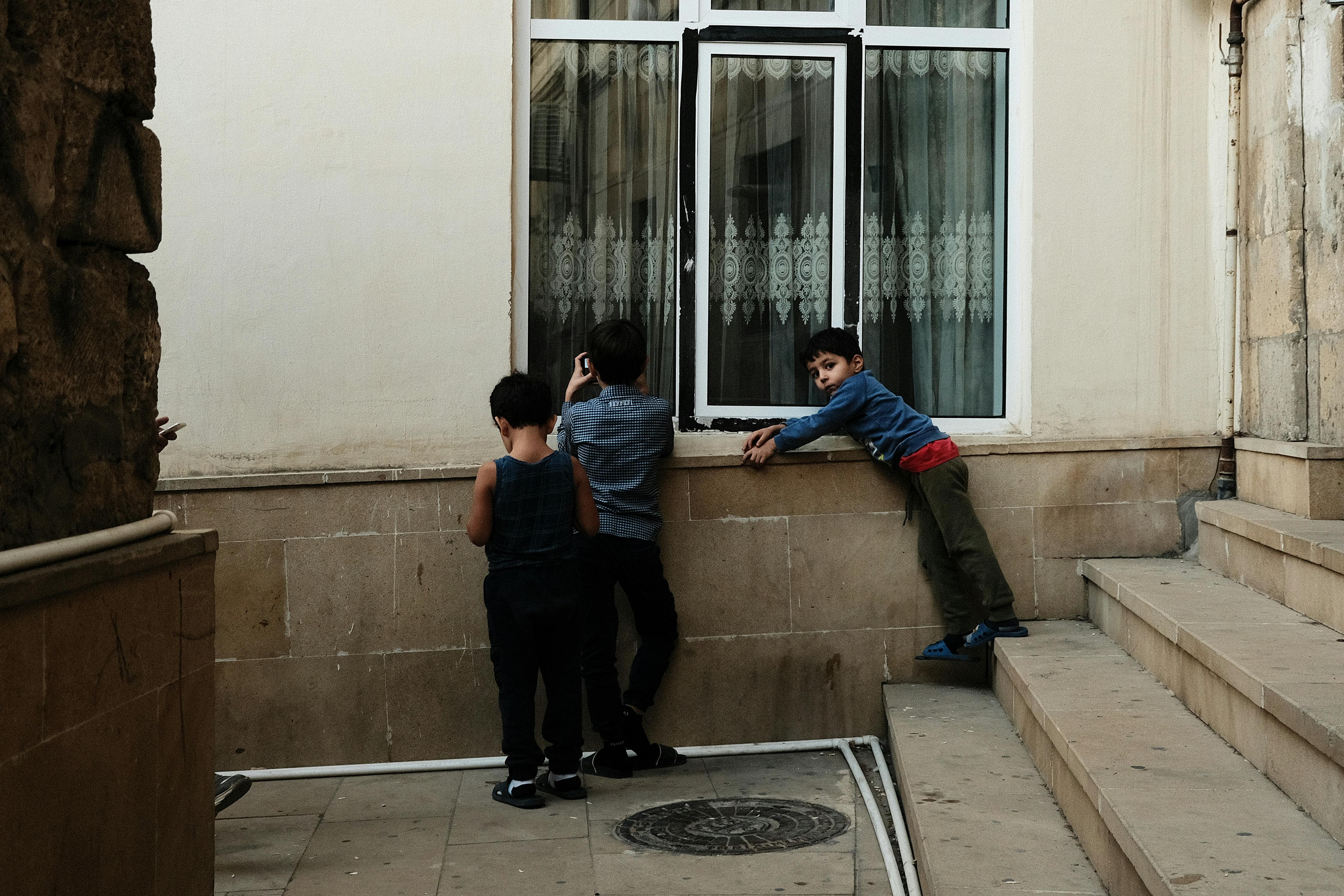 Three Boys Standing by the Window · Free Stock Photo