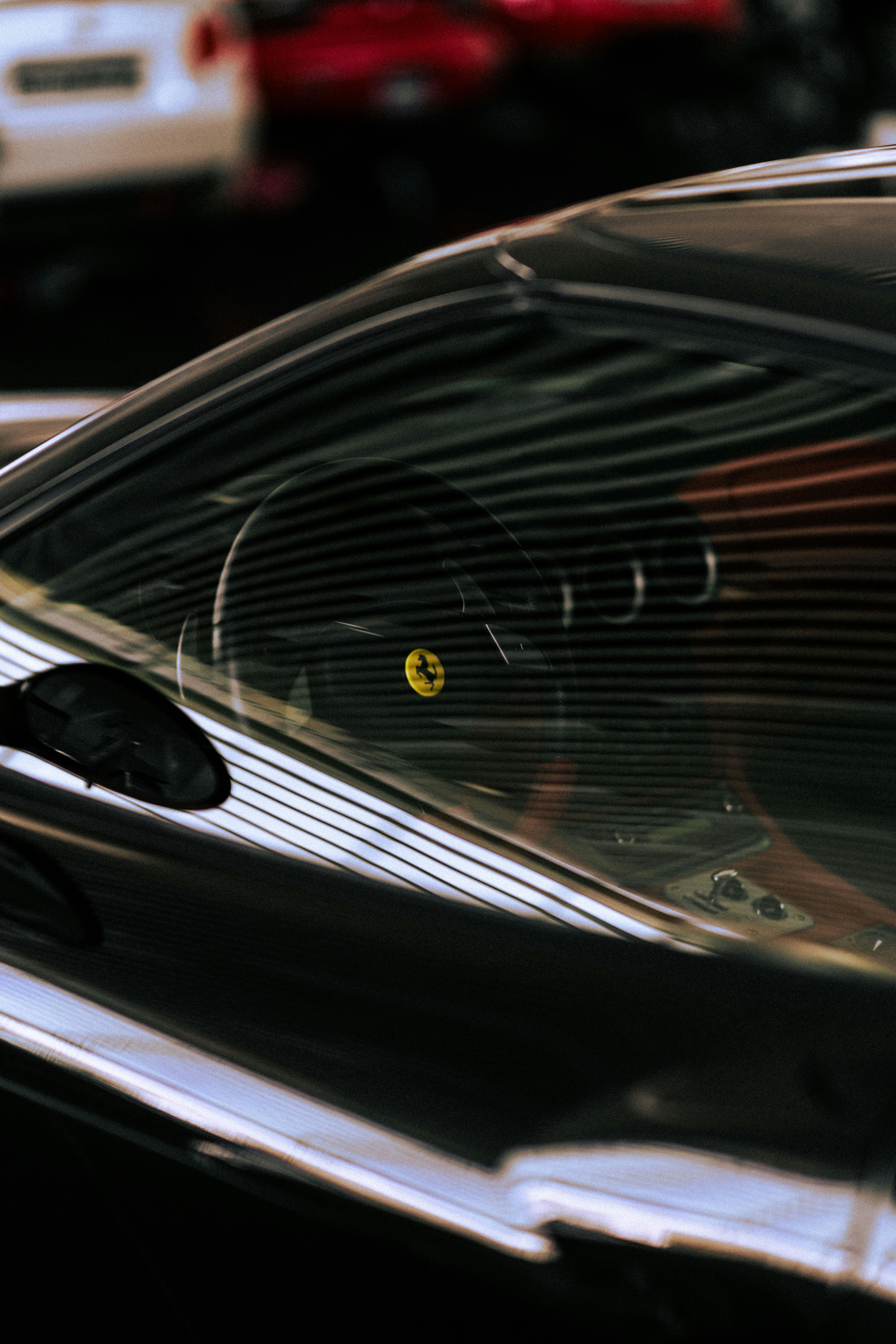 A ferrari car is shown in the reflection of a window · Free Stock Photo