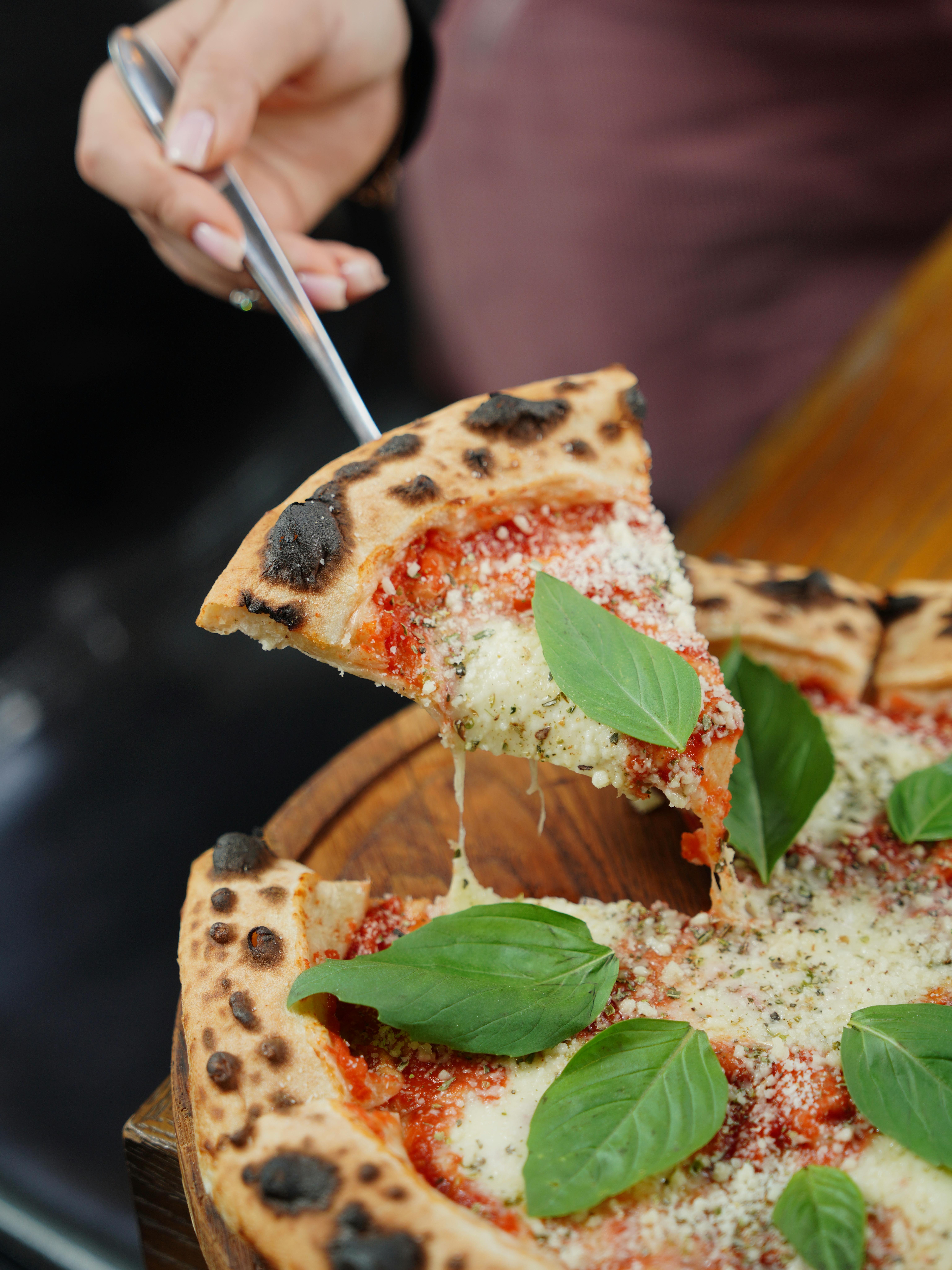 Pizza Slice in Hand · Free Stock Photo