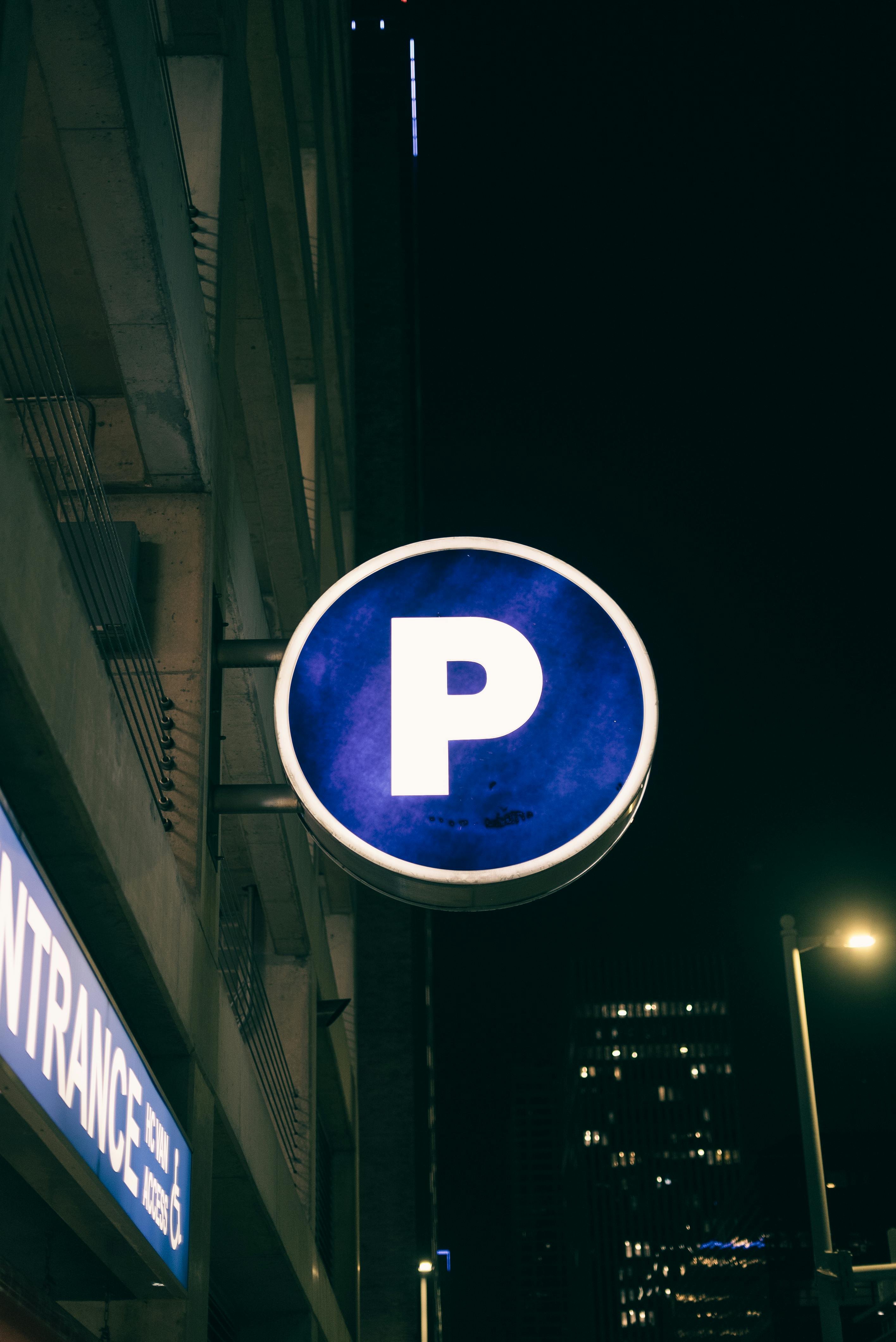 Illuminated Sign on Night City Street · Free Stock Photo