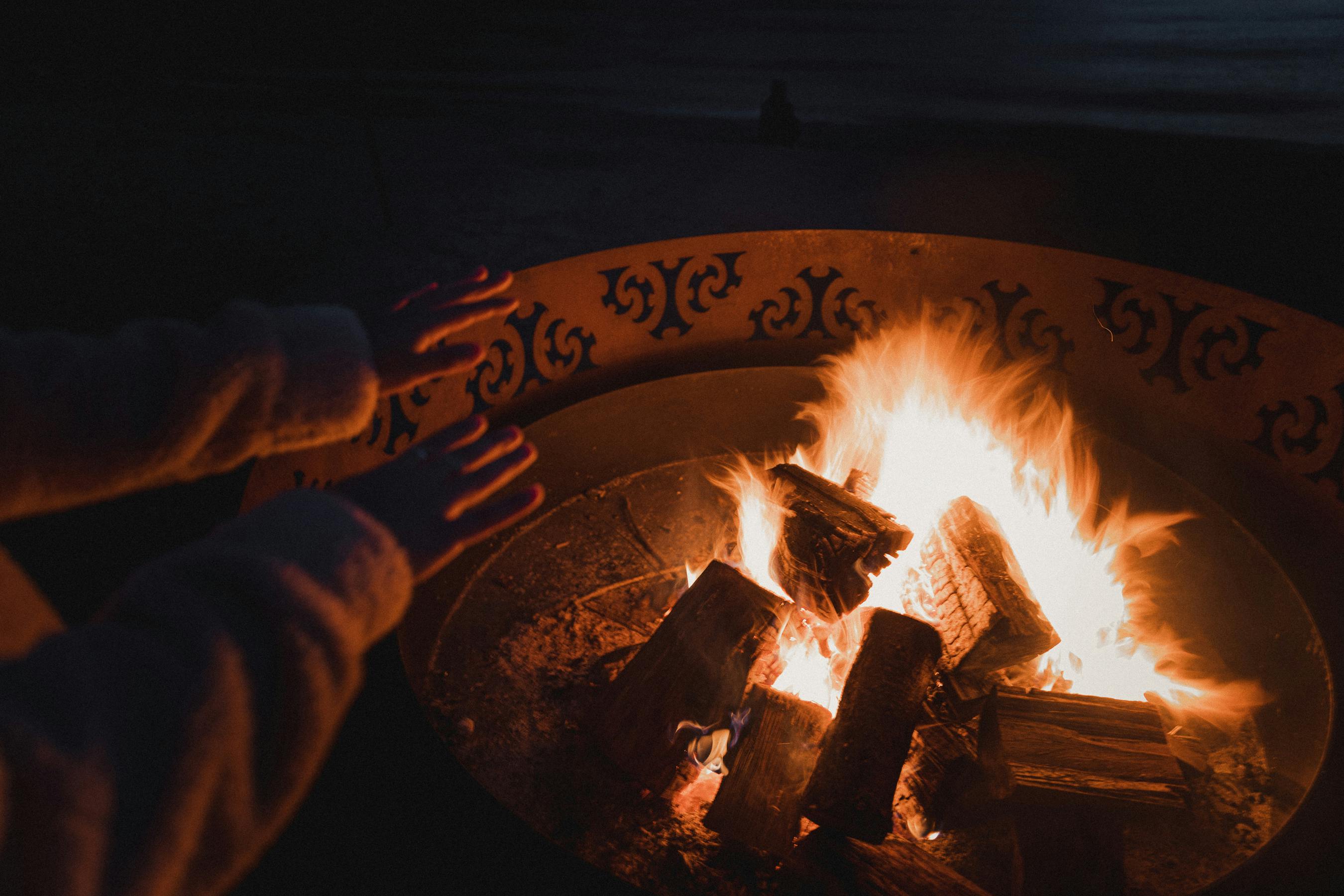 Warming Hands over Bonfire at Night · Free Stock Photo