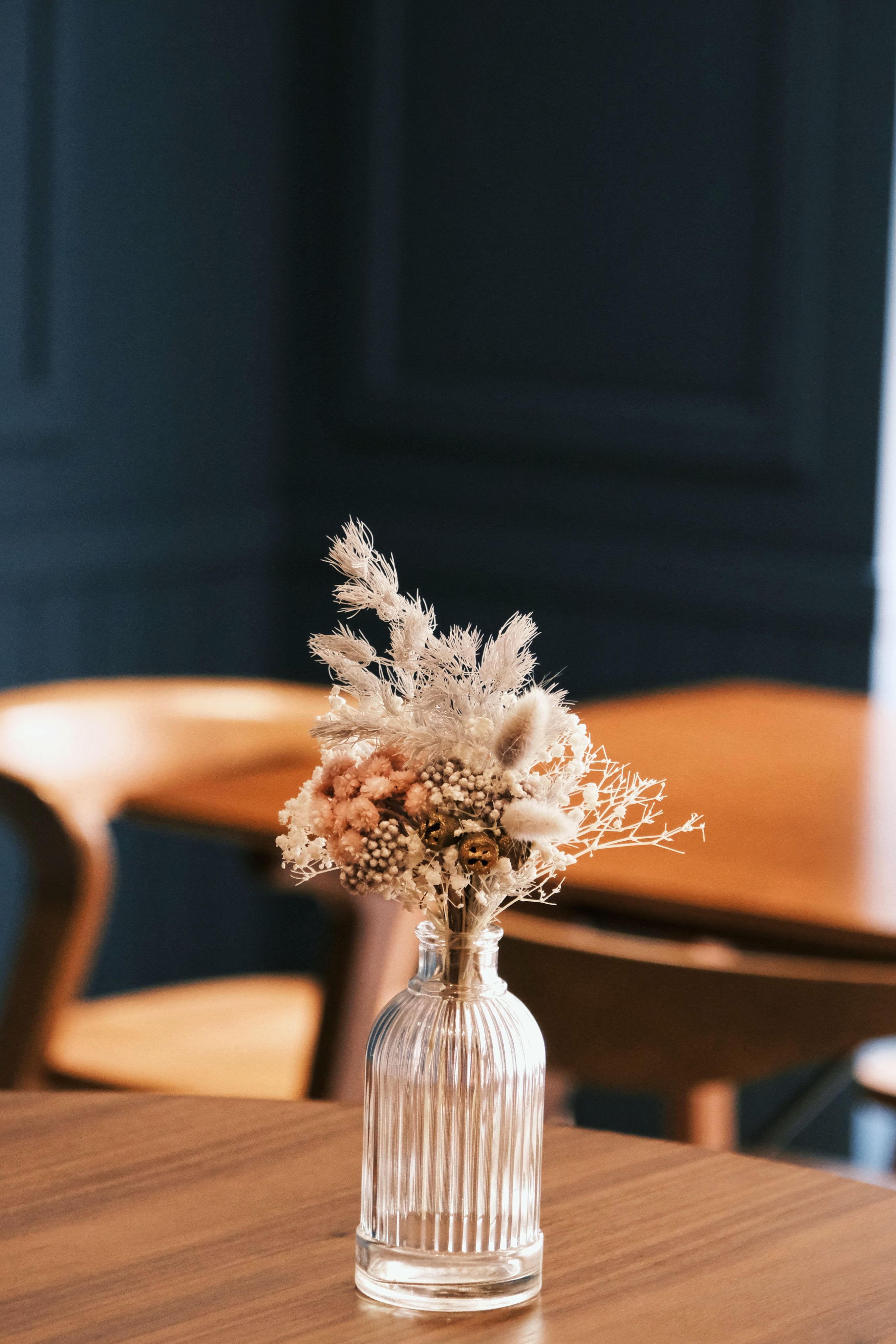 Flower Arrangement in a Glass Vase Standing on a Cafe Table · Free ...