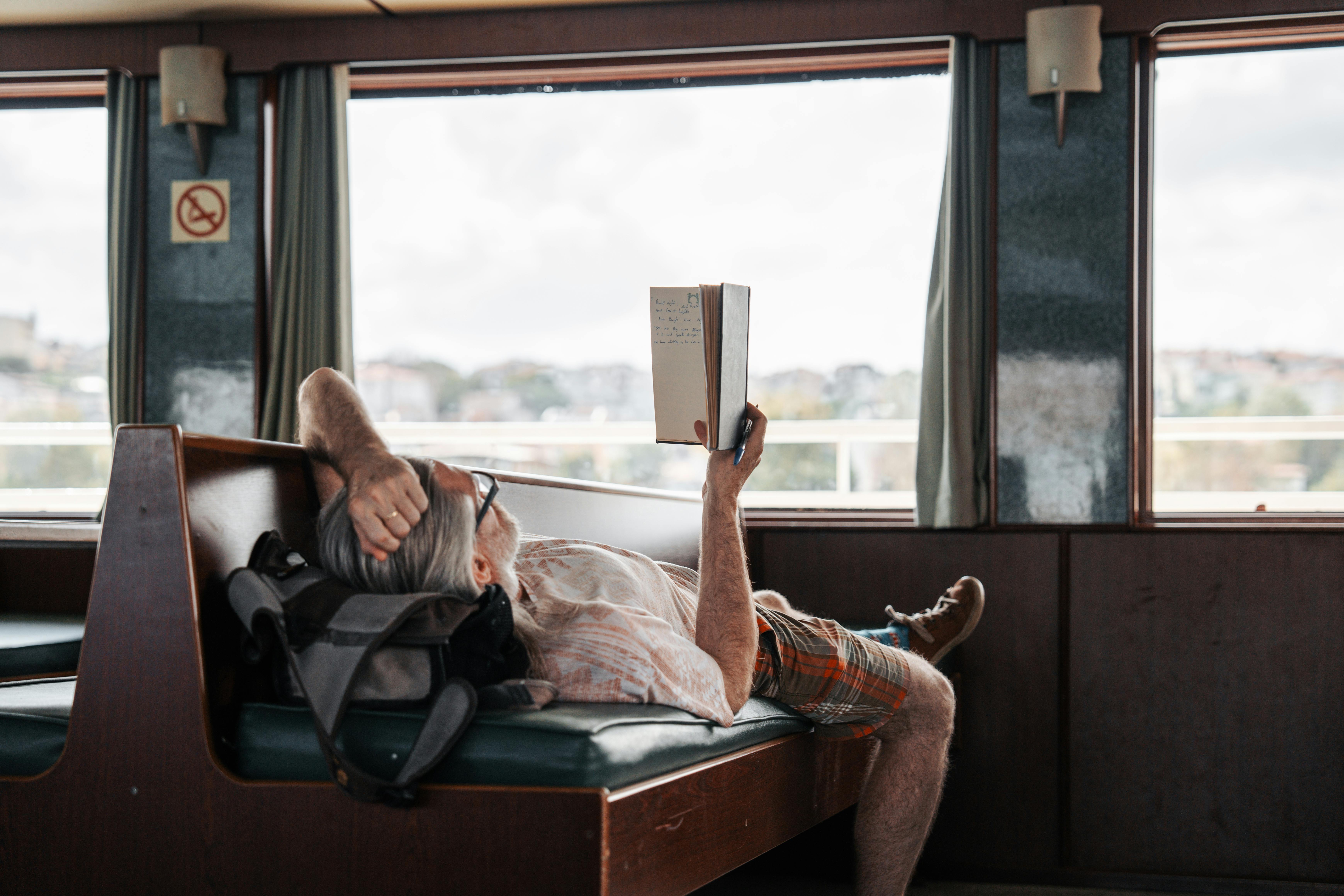 Man on the Train Reading · Free Stock Photo