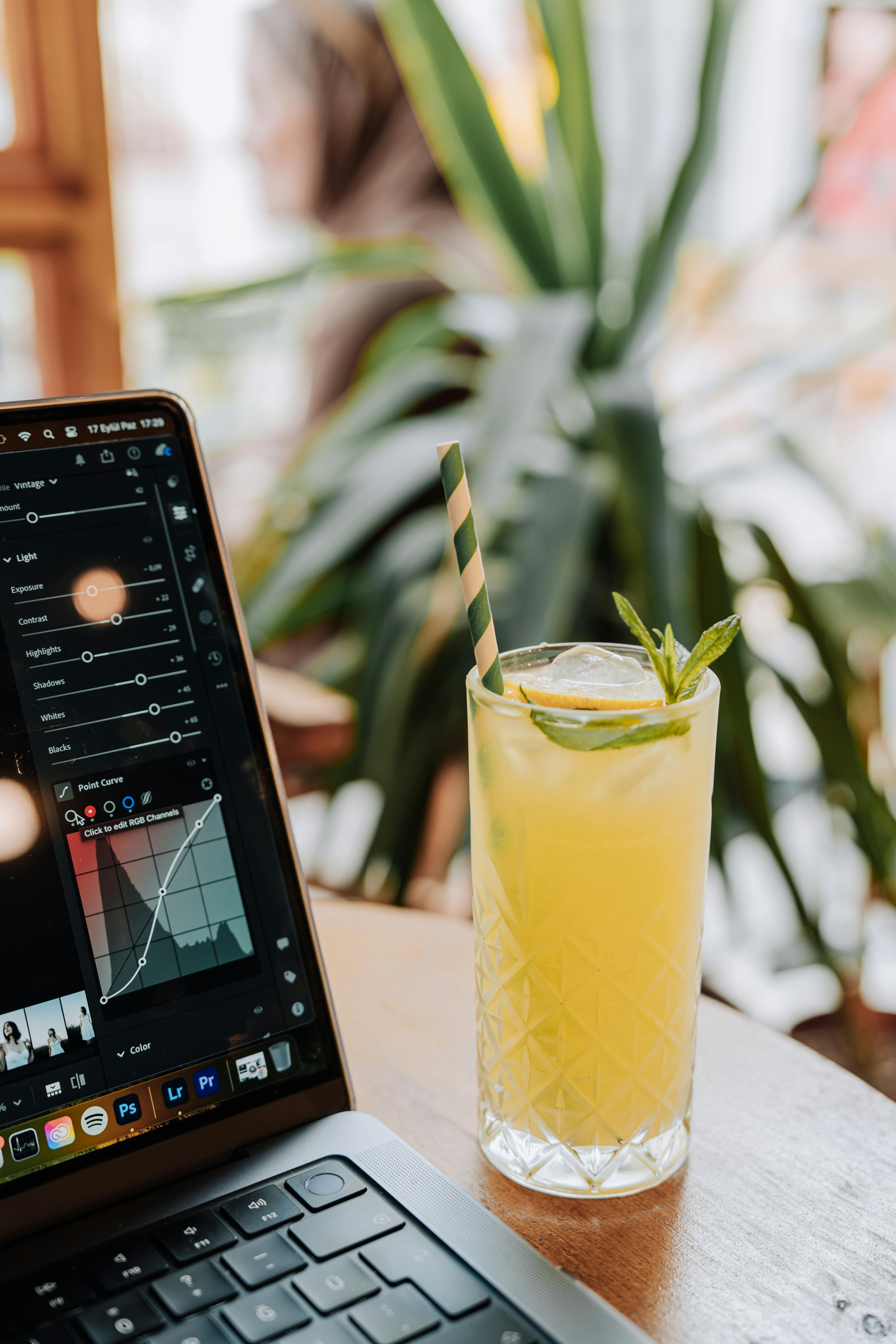 Glass with a Drink and a Straw by a Laptop · Free Stock Photo