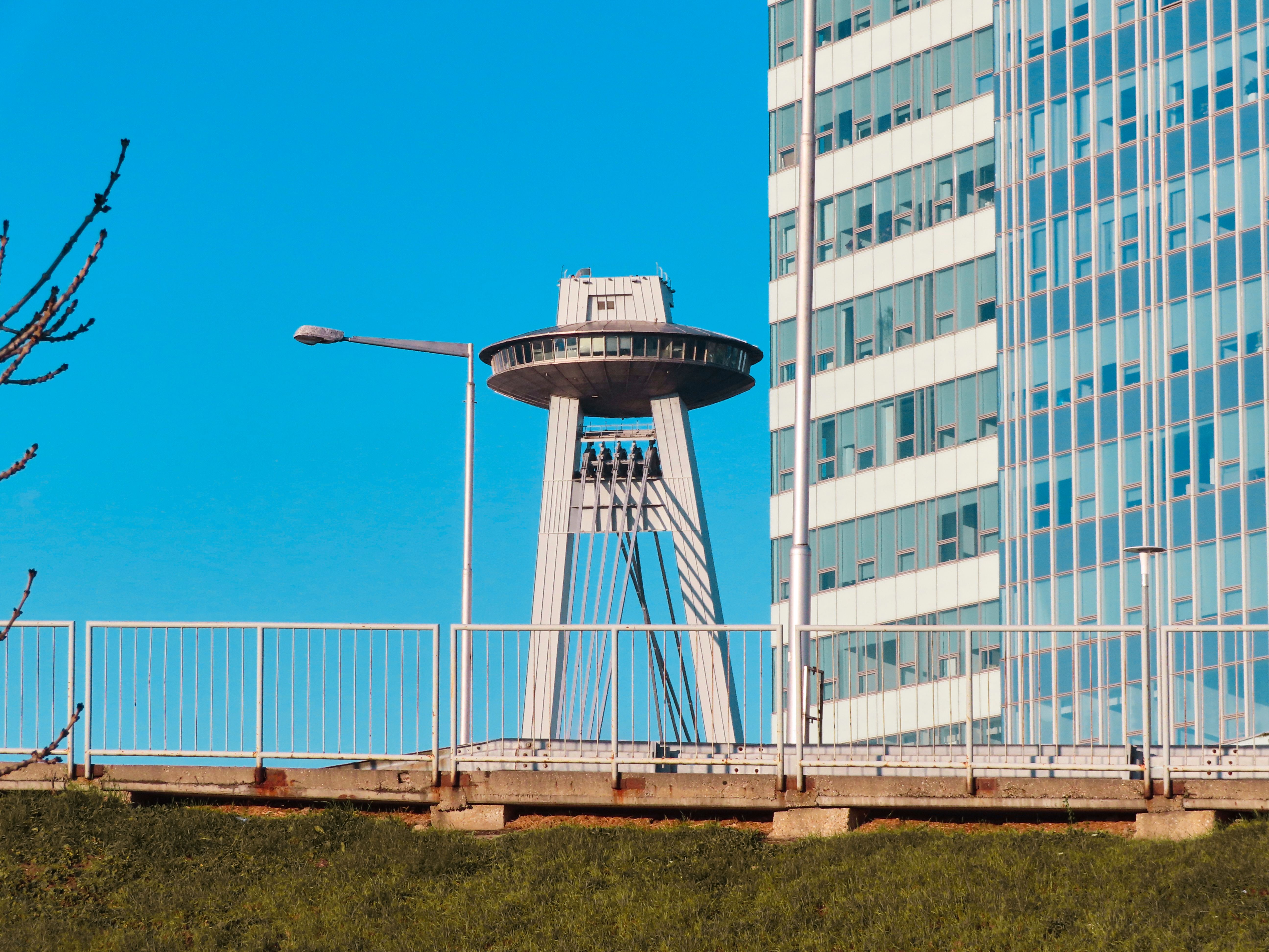 Television Tower and Building against Blue Sky · Free Stock Photo