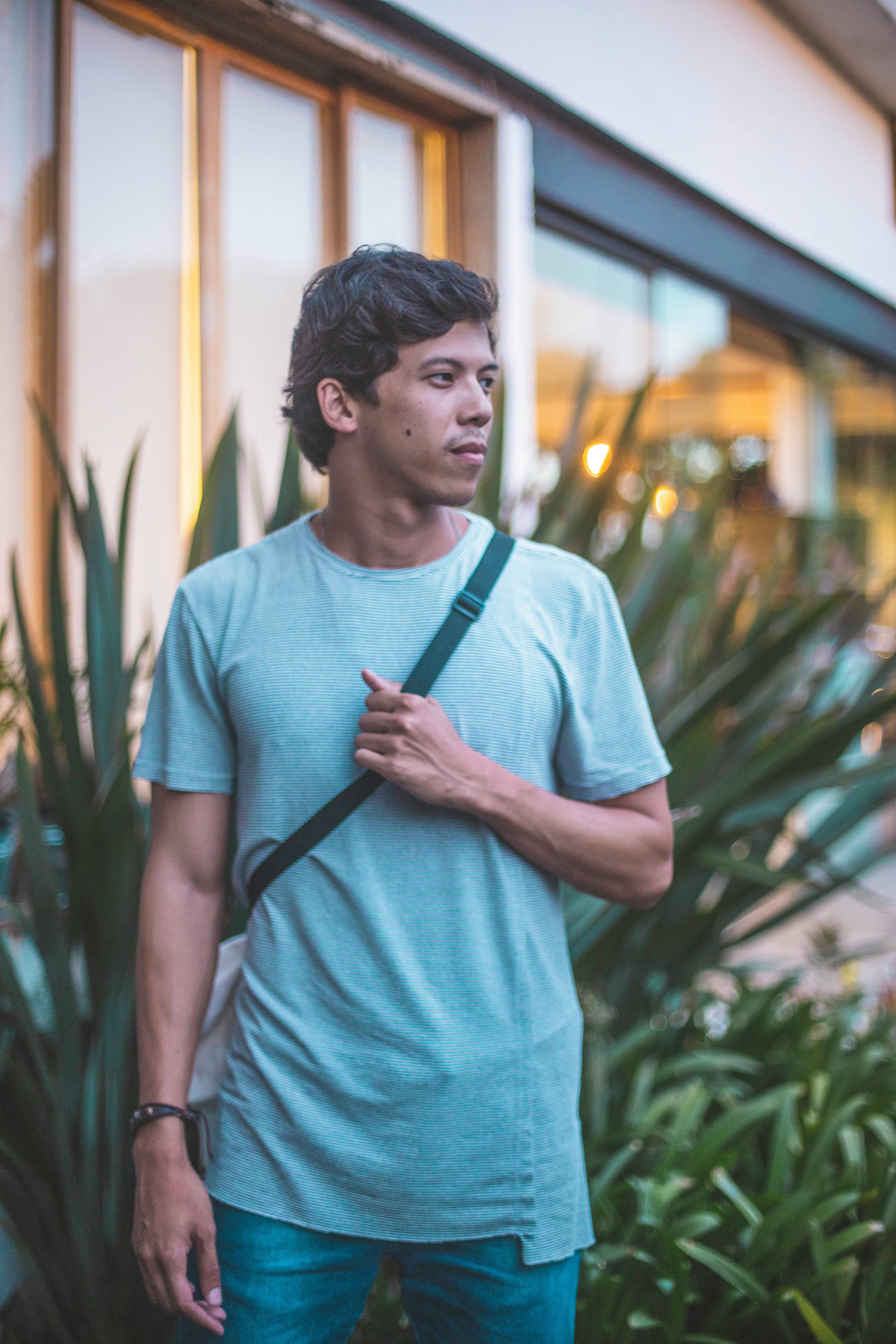 Man Holding Black Bag Strap Outdoor · Free Stock Photo