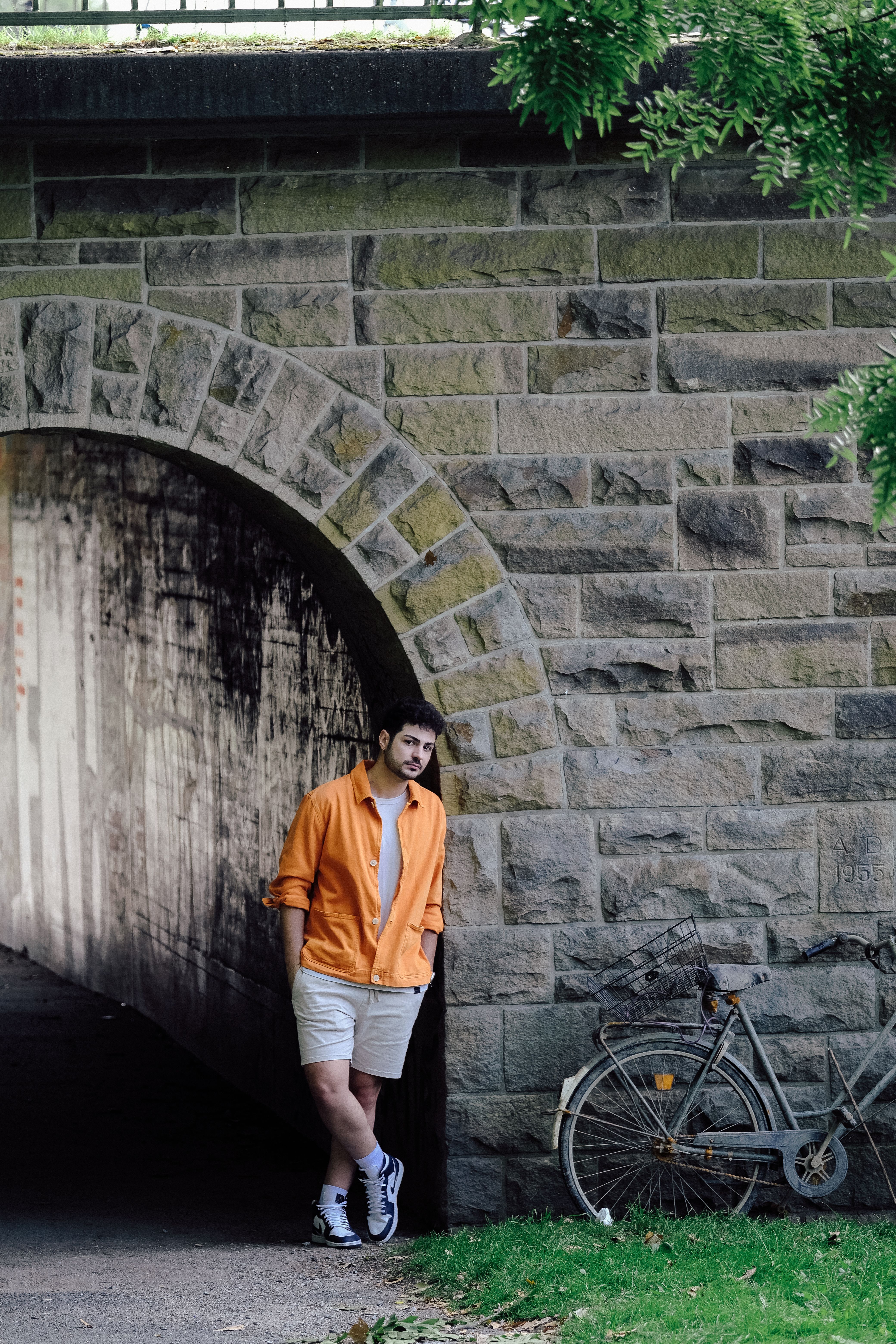 Man Standing and Posing by Stone Wall · Free Stock Photo