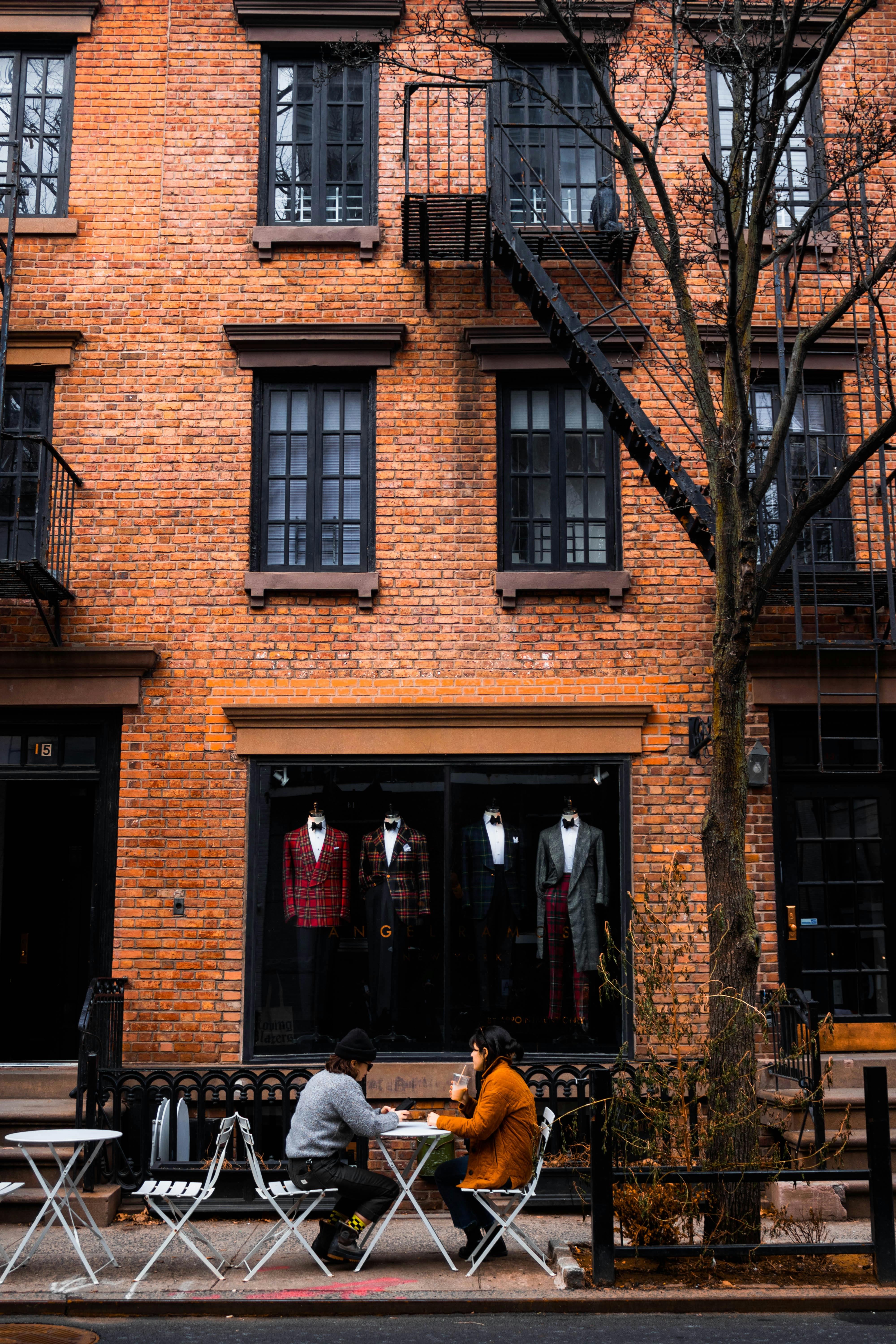 Two People Having Drinks at a Sidewalk Cafe · Free Stock Photo
