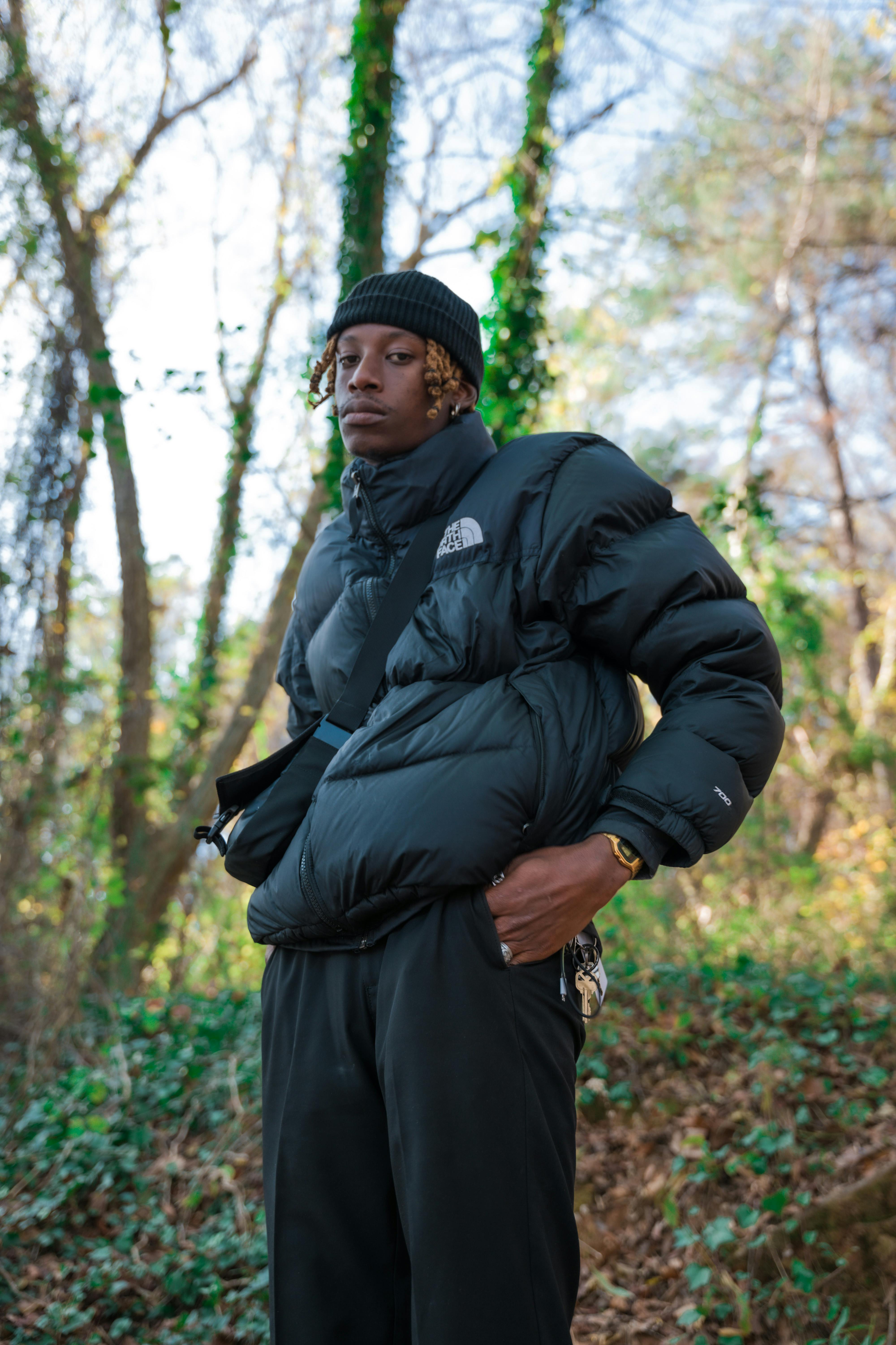 Young Man in a Quilted Jacket with a Sling Bag · Free Stock Photo