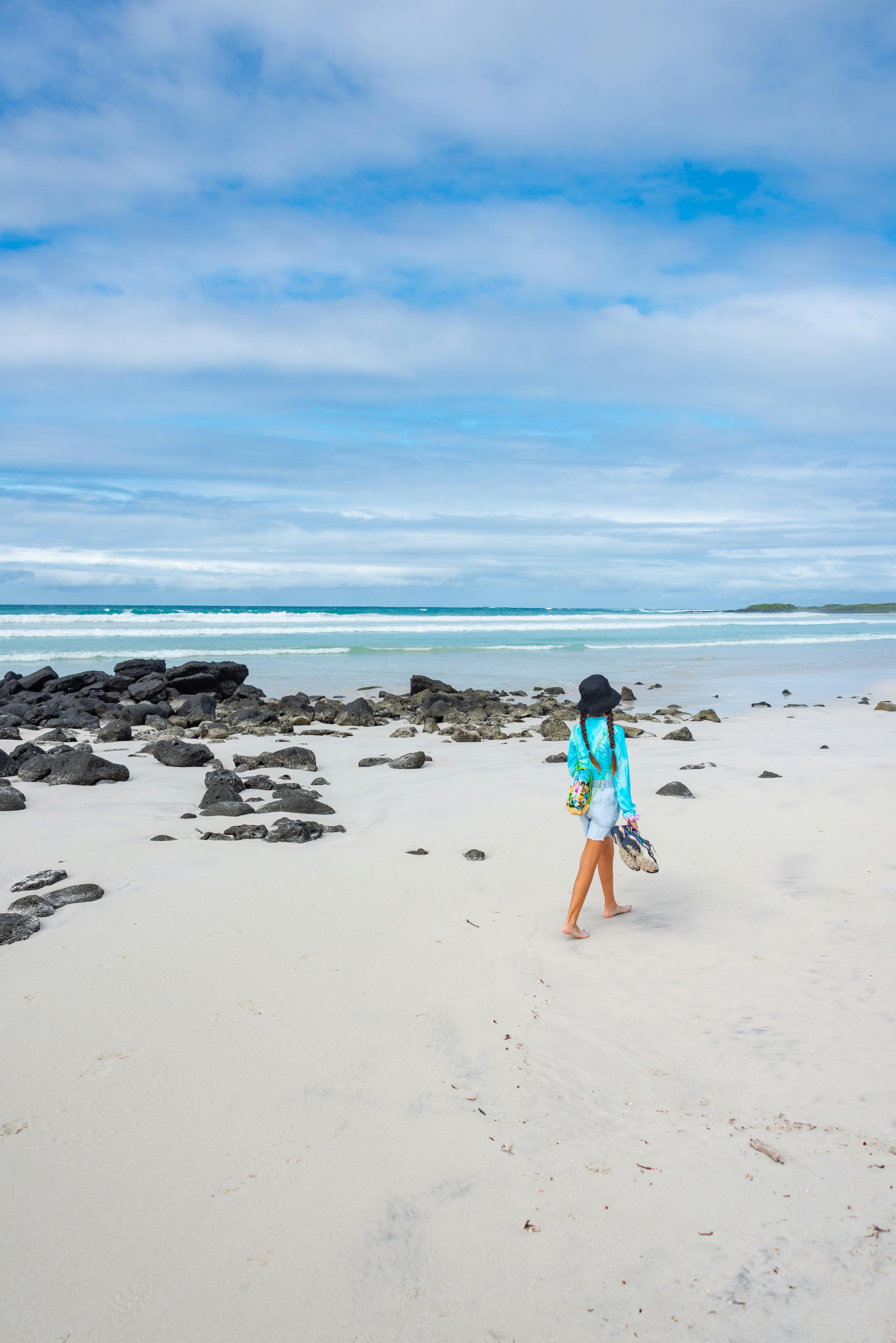 Group of Young Tourists Entering the Sea Watched by a Woman Sunbathing ...