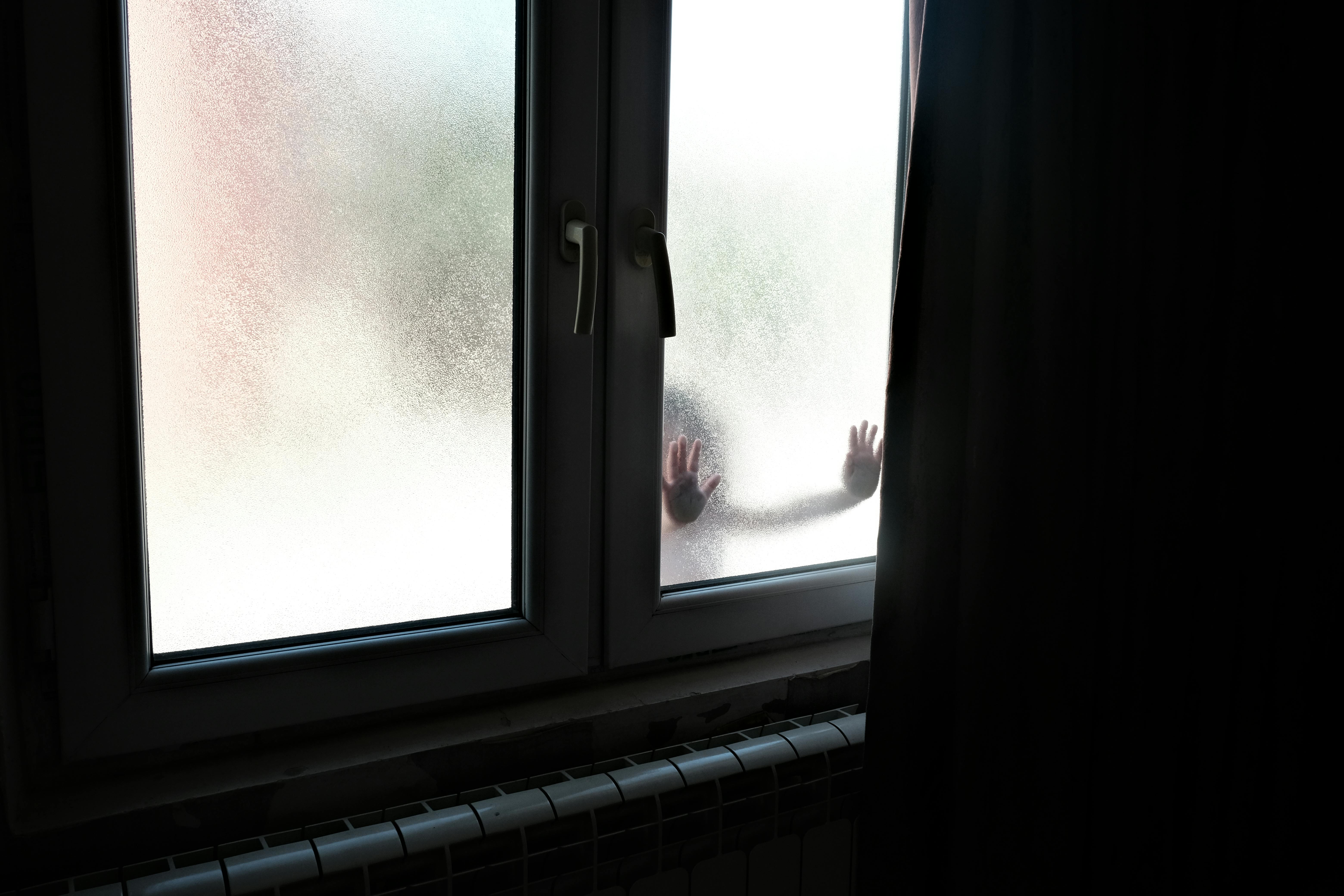 Silhouette of a Woman Standing Behind Glass Panel · Free Stock Photo
