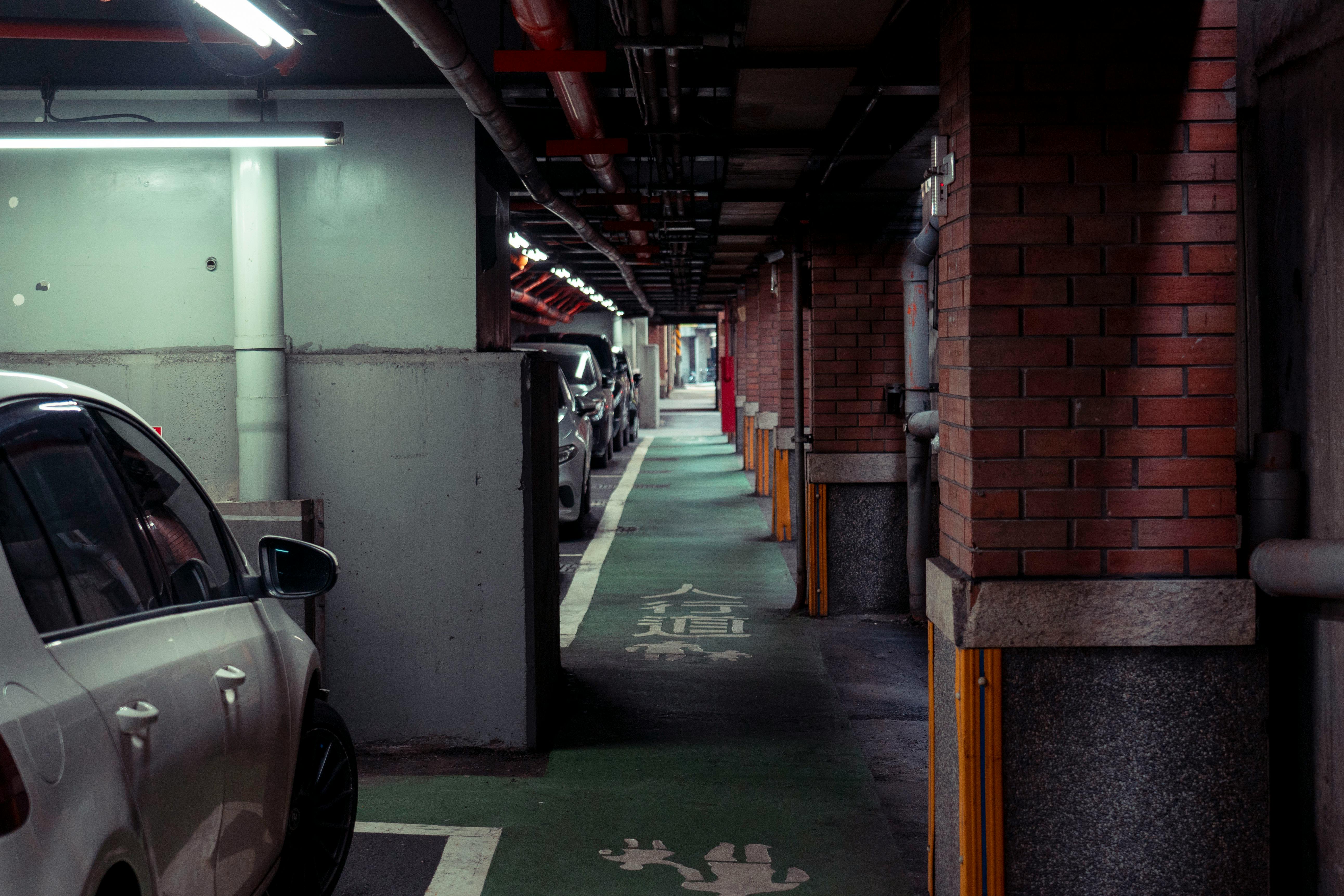 Passage between Pillars and Cars Parked in Garage · Free Stock Photo