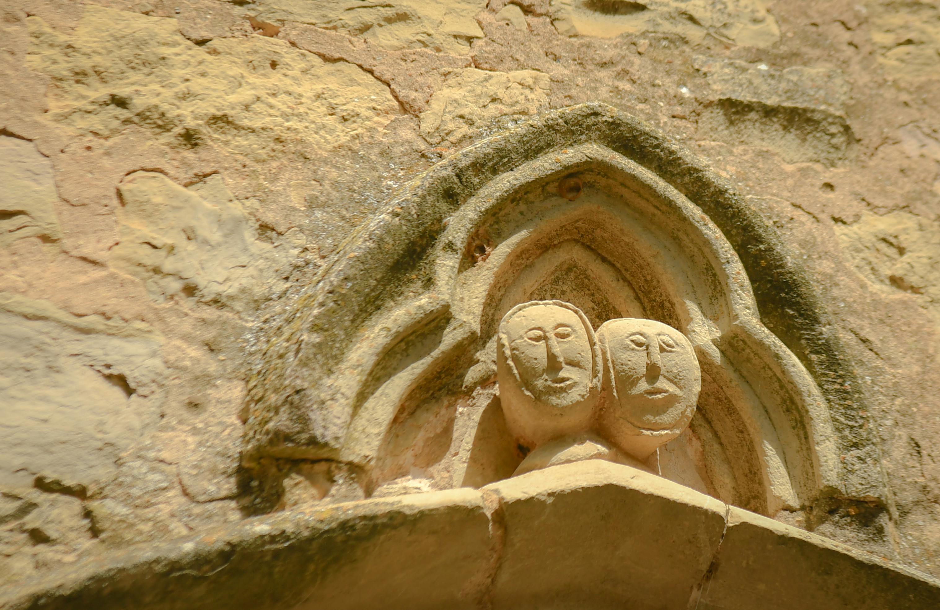 Ancient Faces Sculptures on Wall · Free Stock Photo