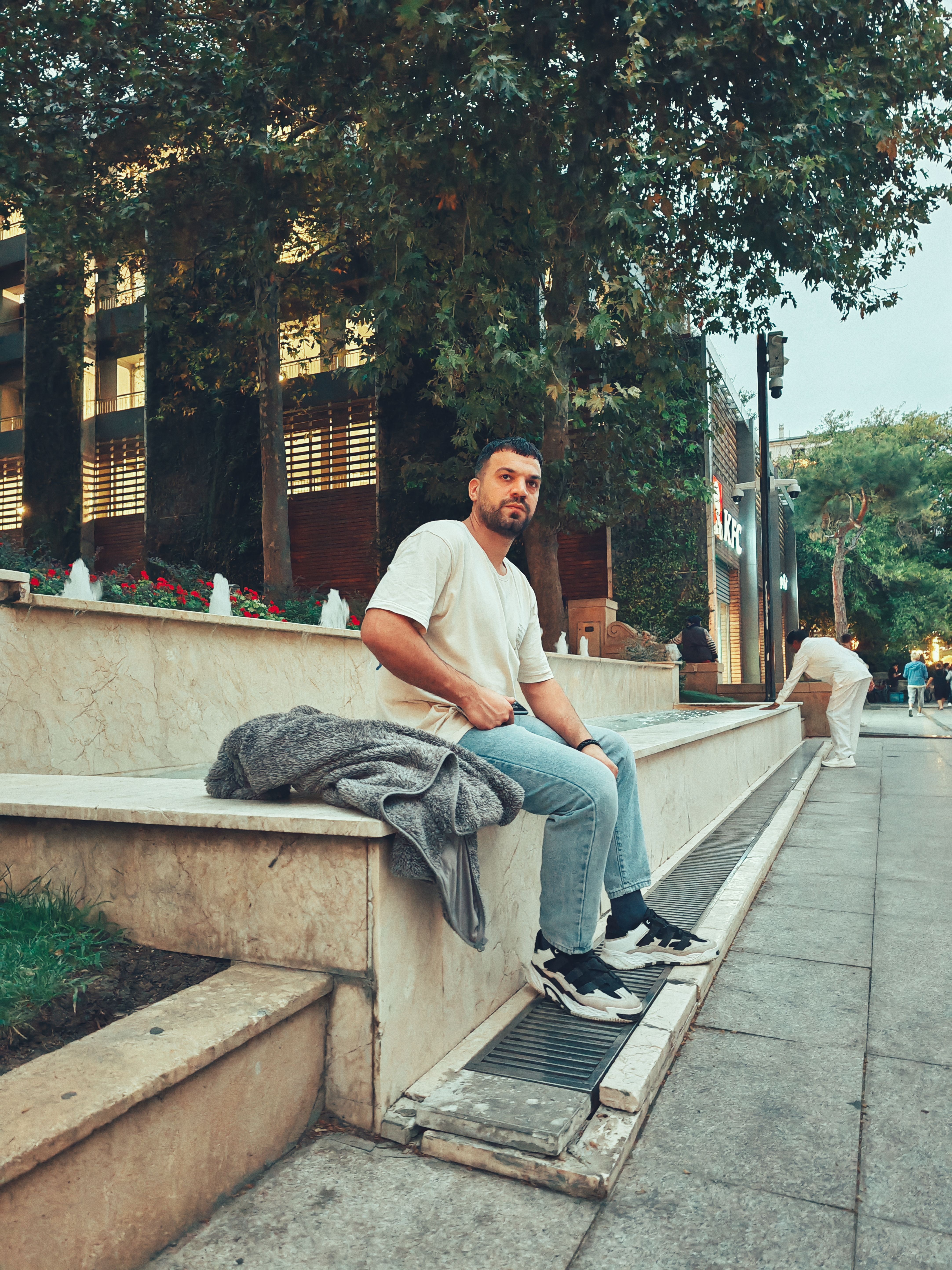 Man Sitting on Wall · Free Stock Photo