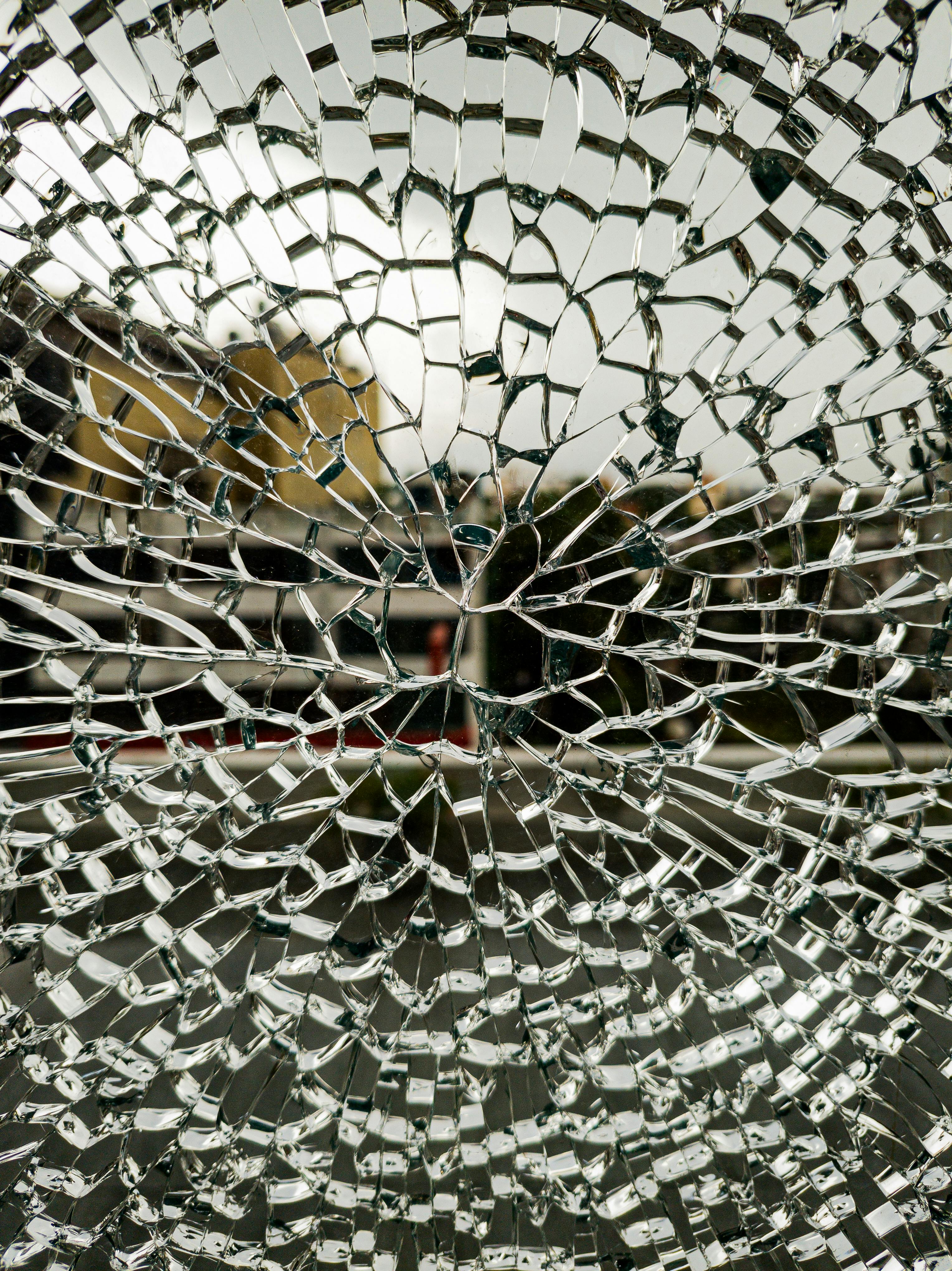 Mirror Fragments on Gray Surface With The Reflection Of A Person's Hand ...