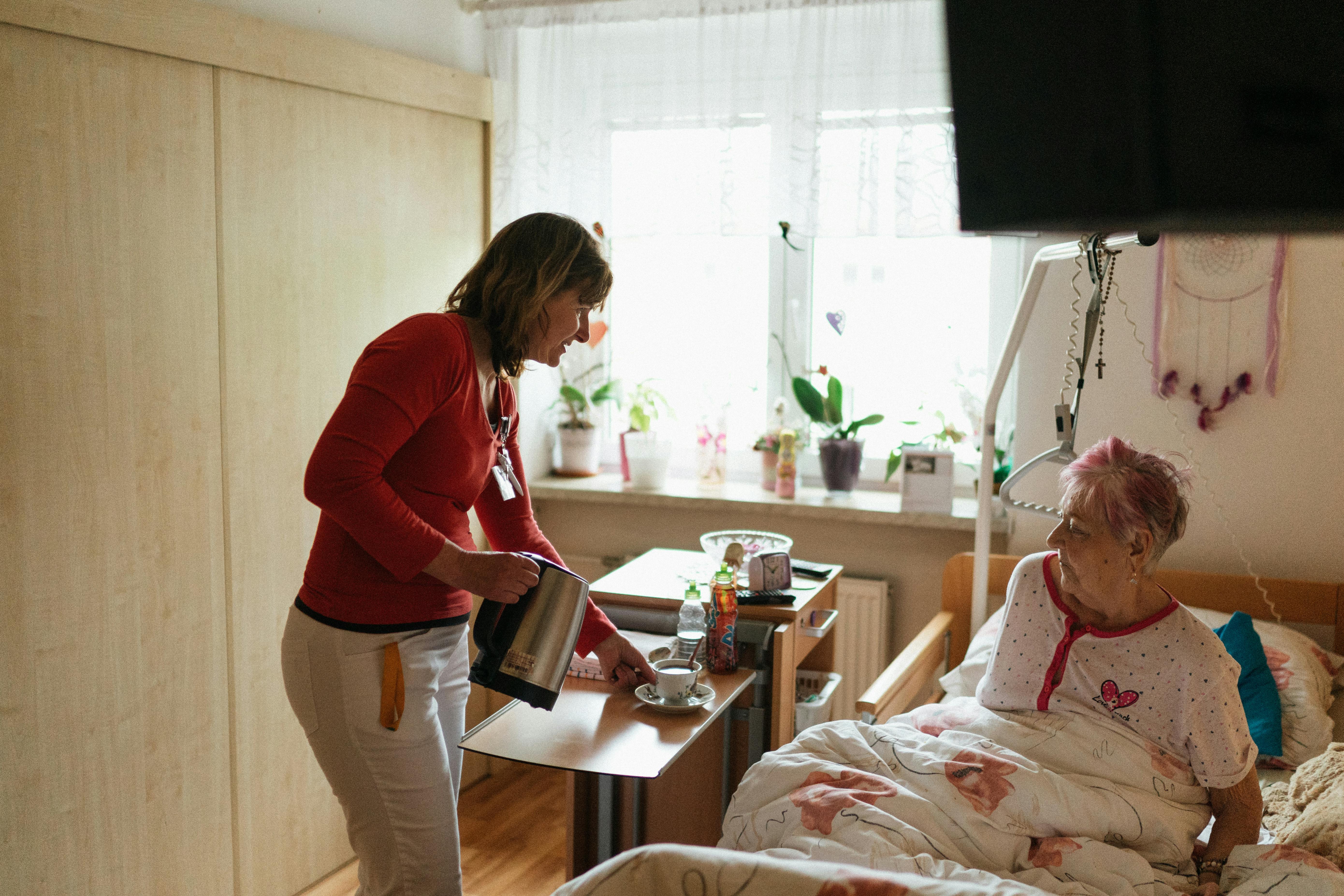Caregiver Helping Elderly People in Nursing Home · Free Stock Photo