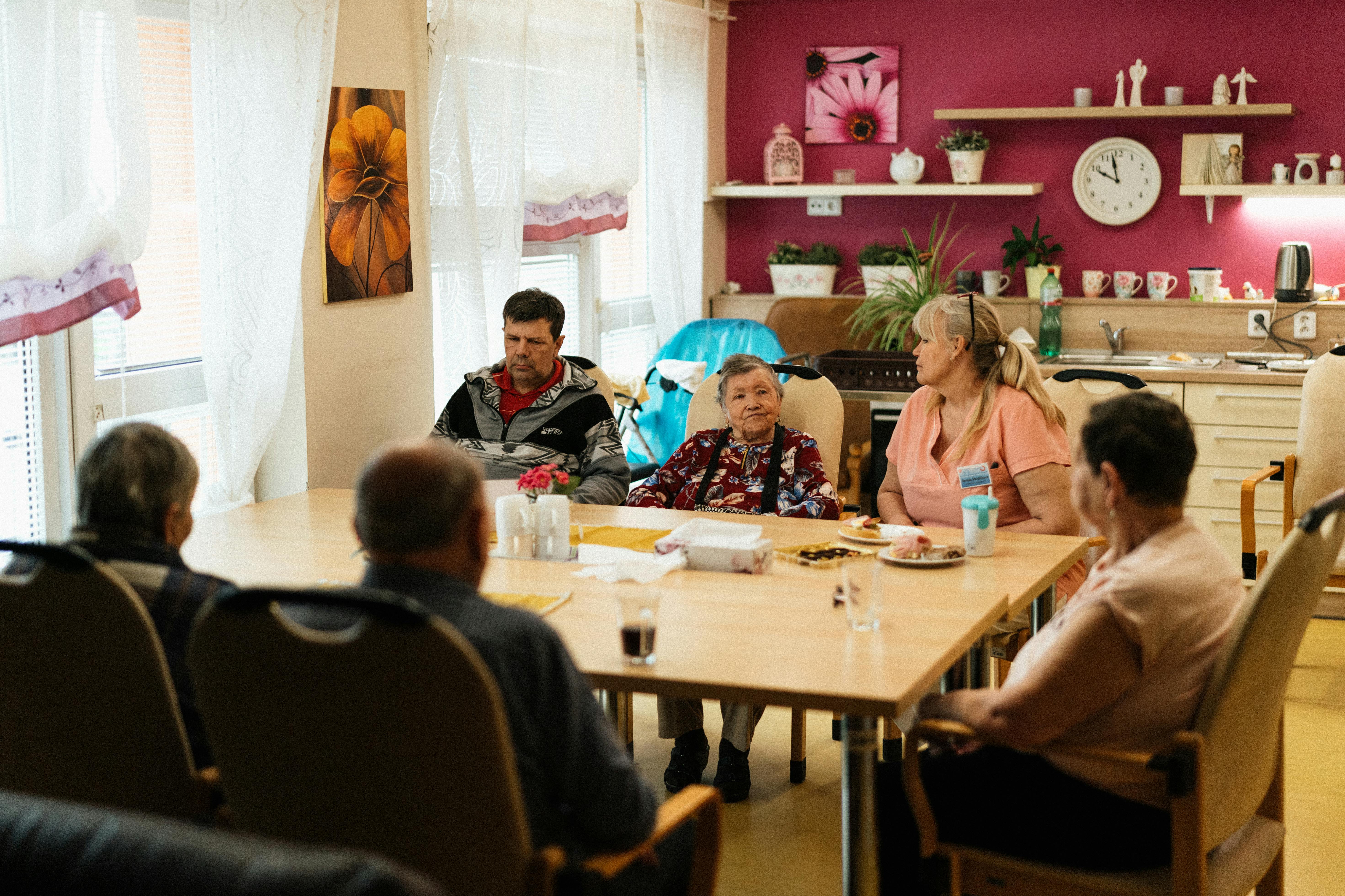 Caregiver Helping Elderly People in Nursing Home · Free Stock Photo