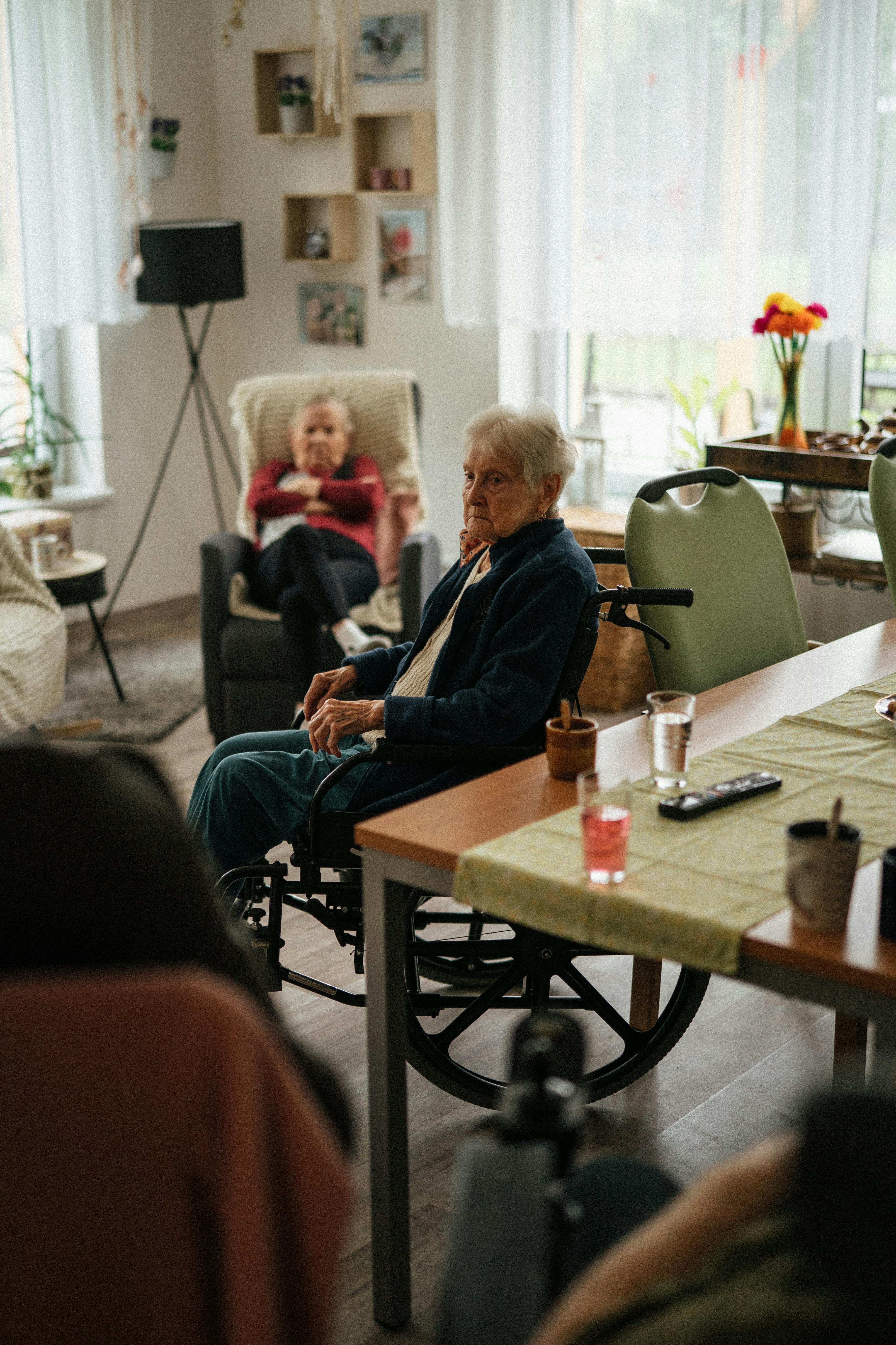 Caregiver Helping Elderly People in Nursing Home · Free Stock Photo