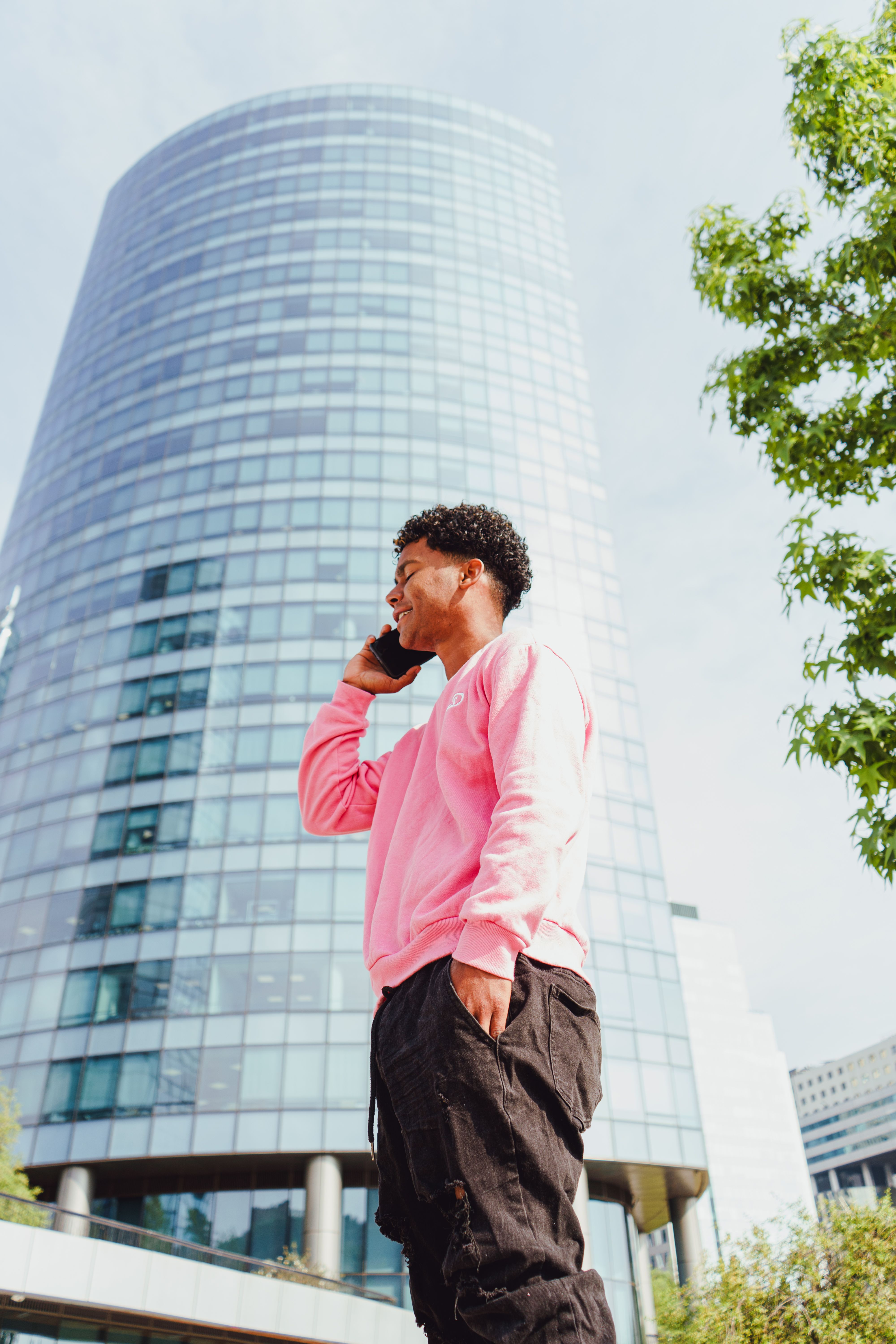 Casual Style Man Talking on Smartphone by Modern Skyscraper · Free ...