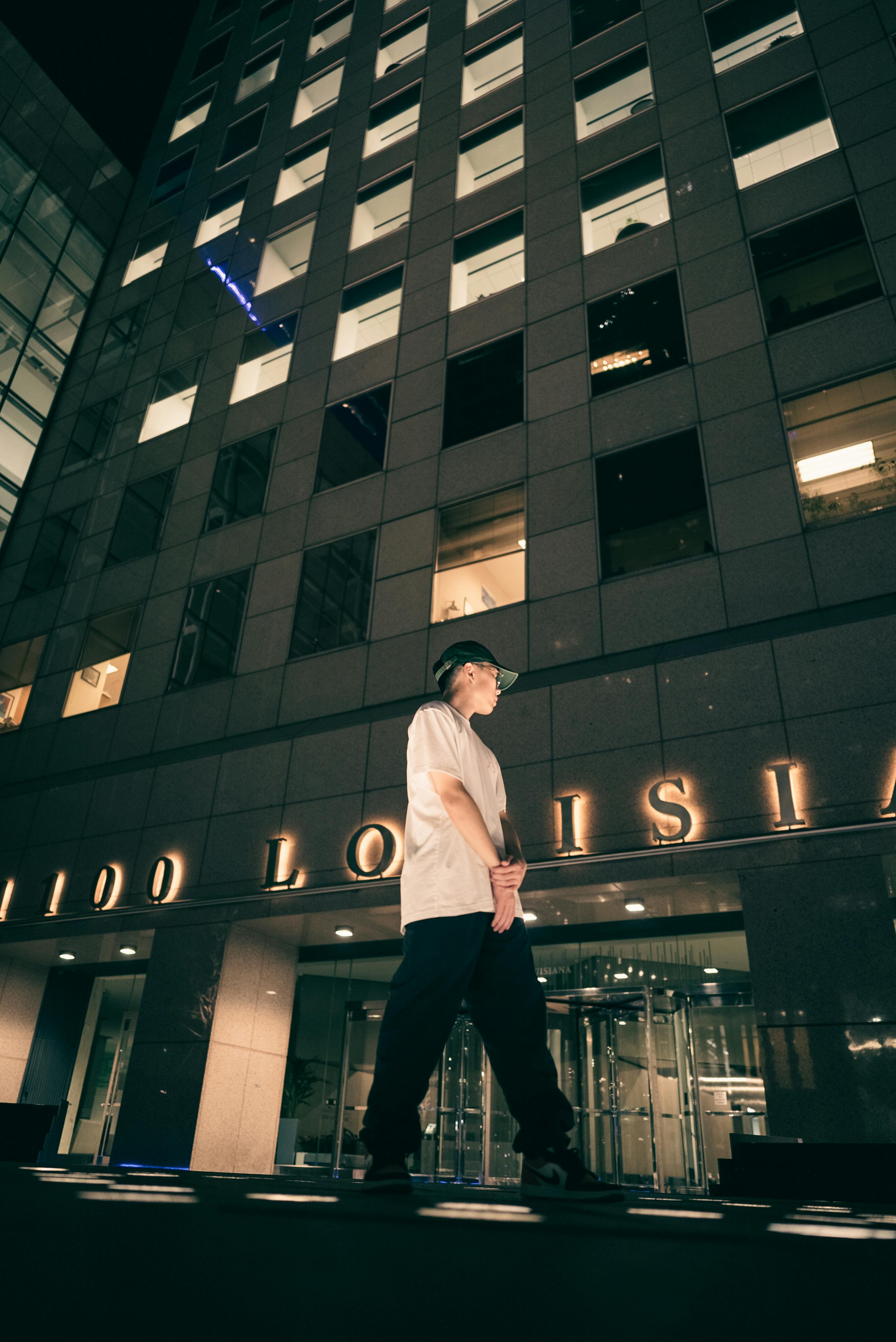 Male Model Posing in Front of the 1100 Louisiana Building at Night ...