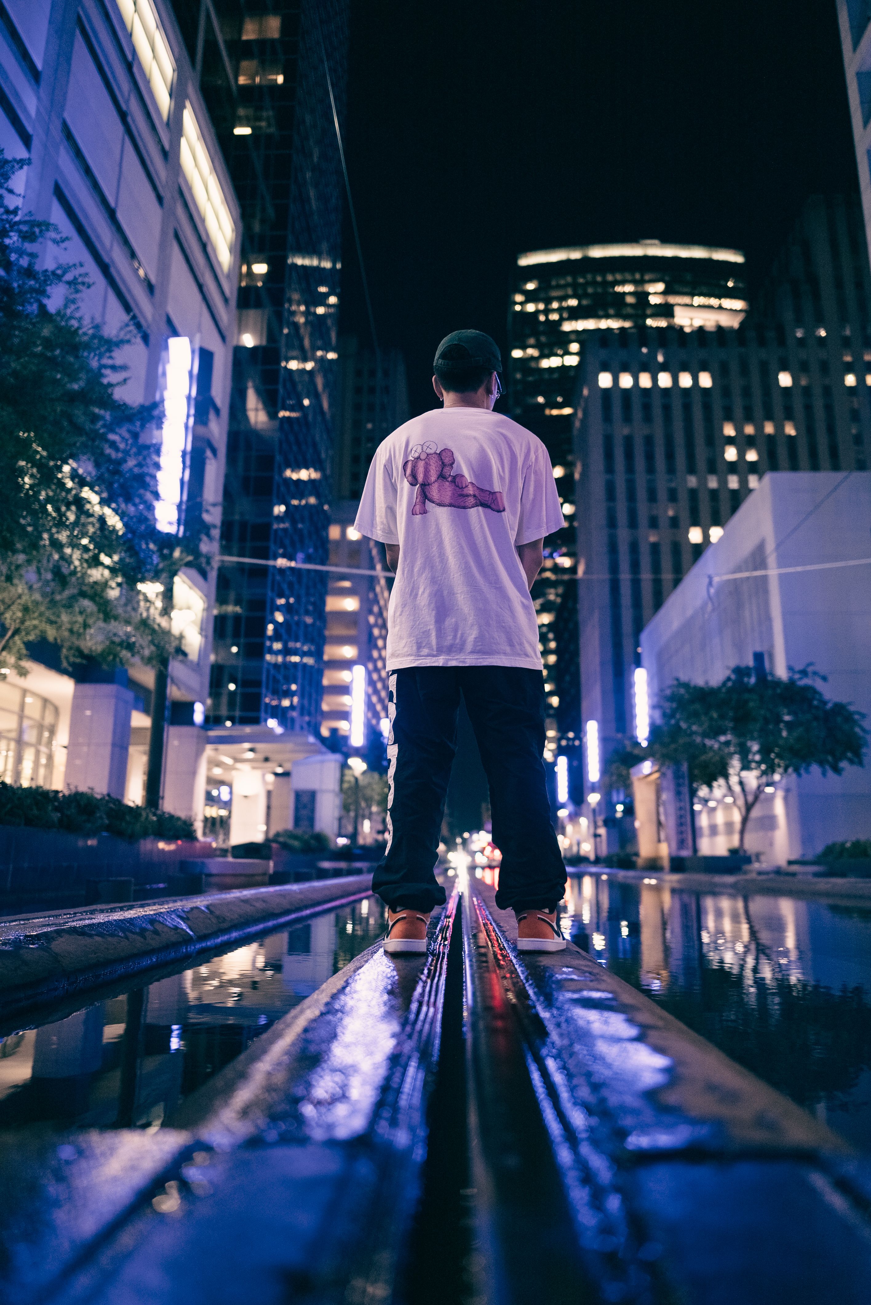 Man Standing in Water Alley in Town at Night · Free Stock Photo