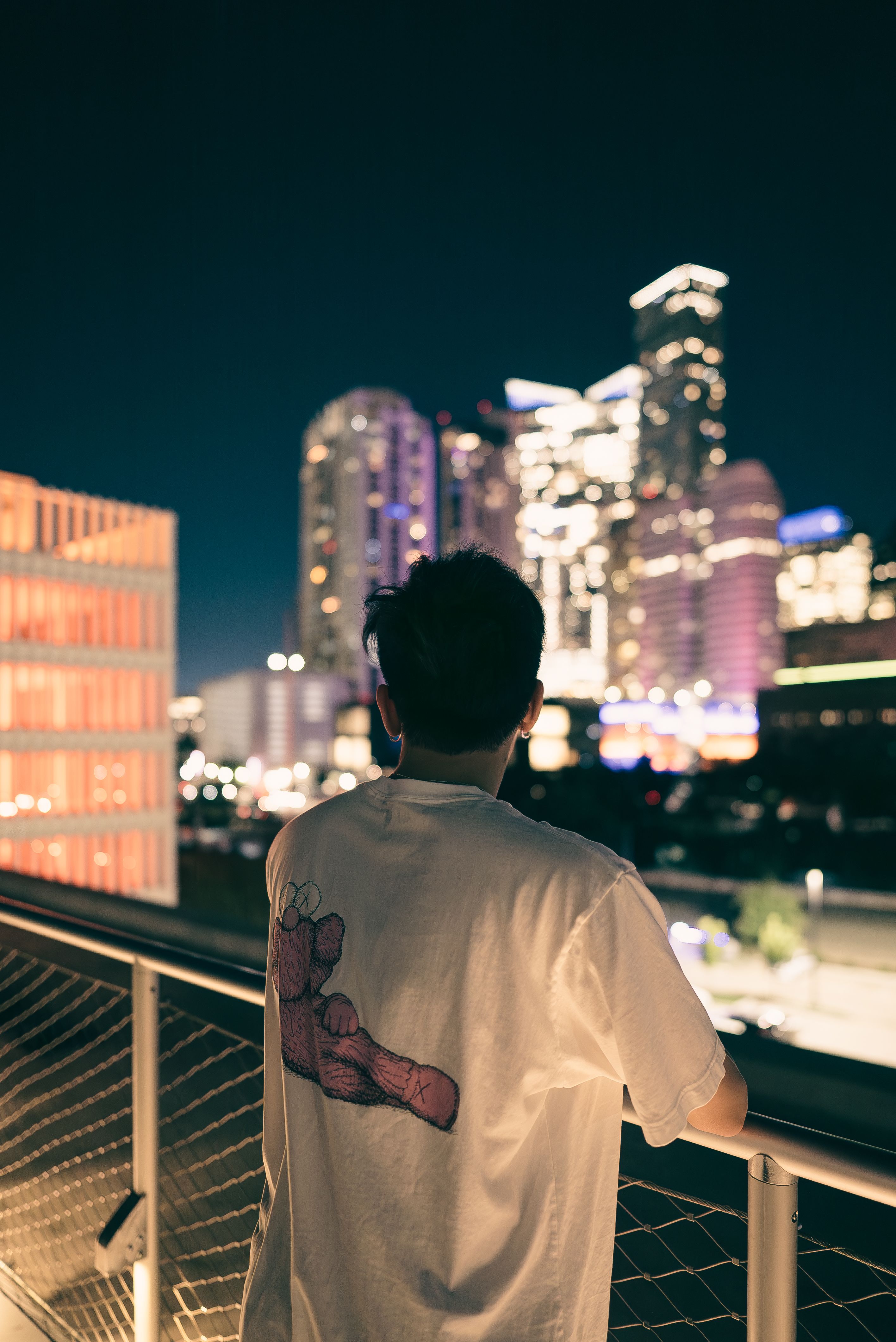 Standing on Terrace Man Looking at Illuminated Night City · Free Stock ...