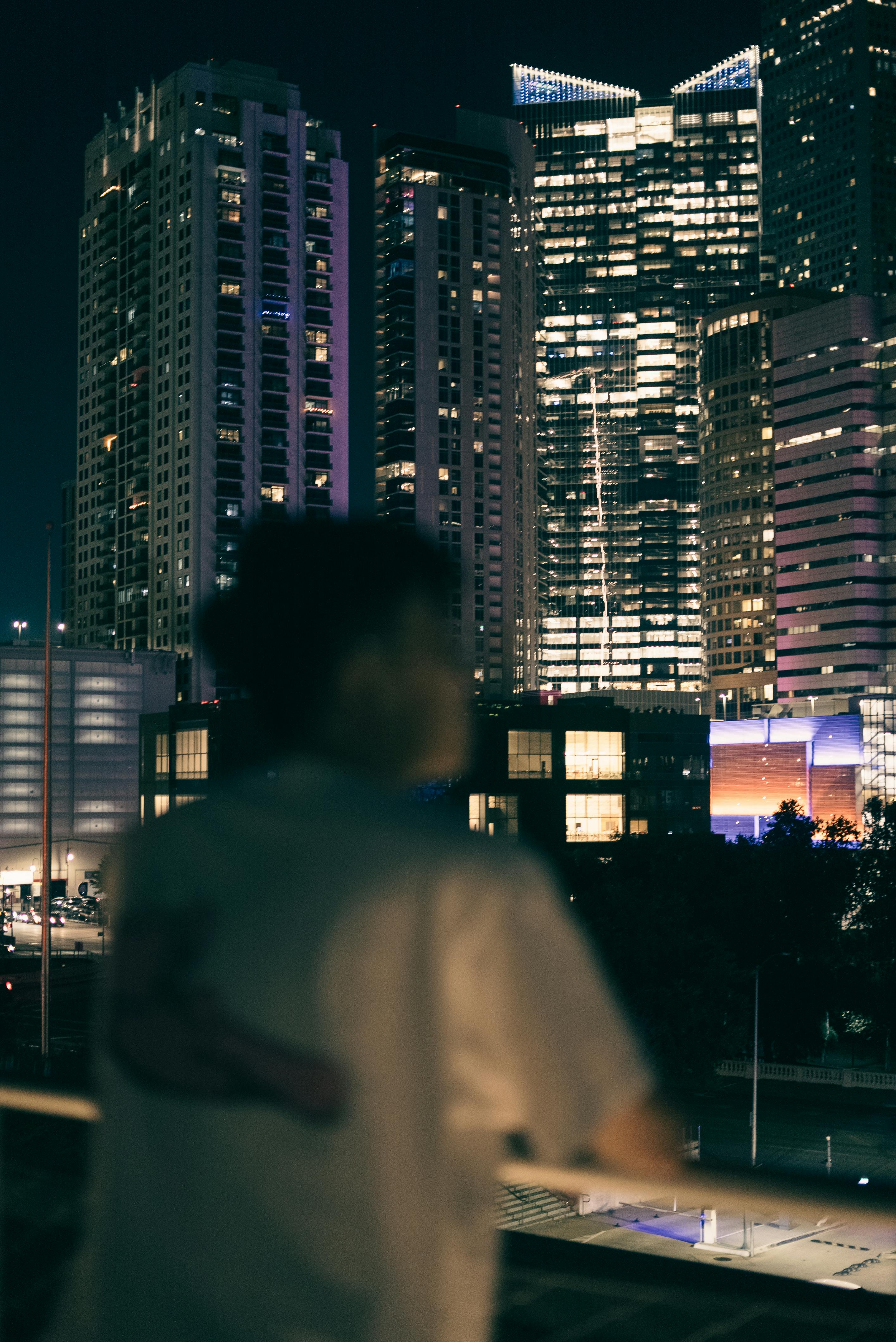 Man and Buildings in City at Night behind · Free Stock Photo