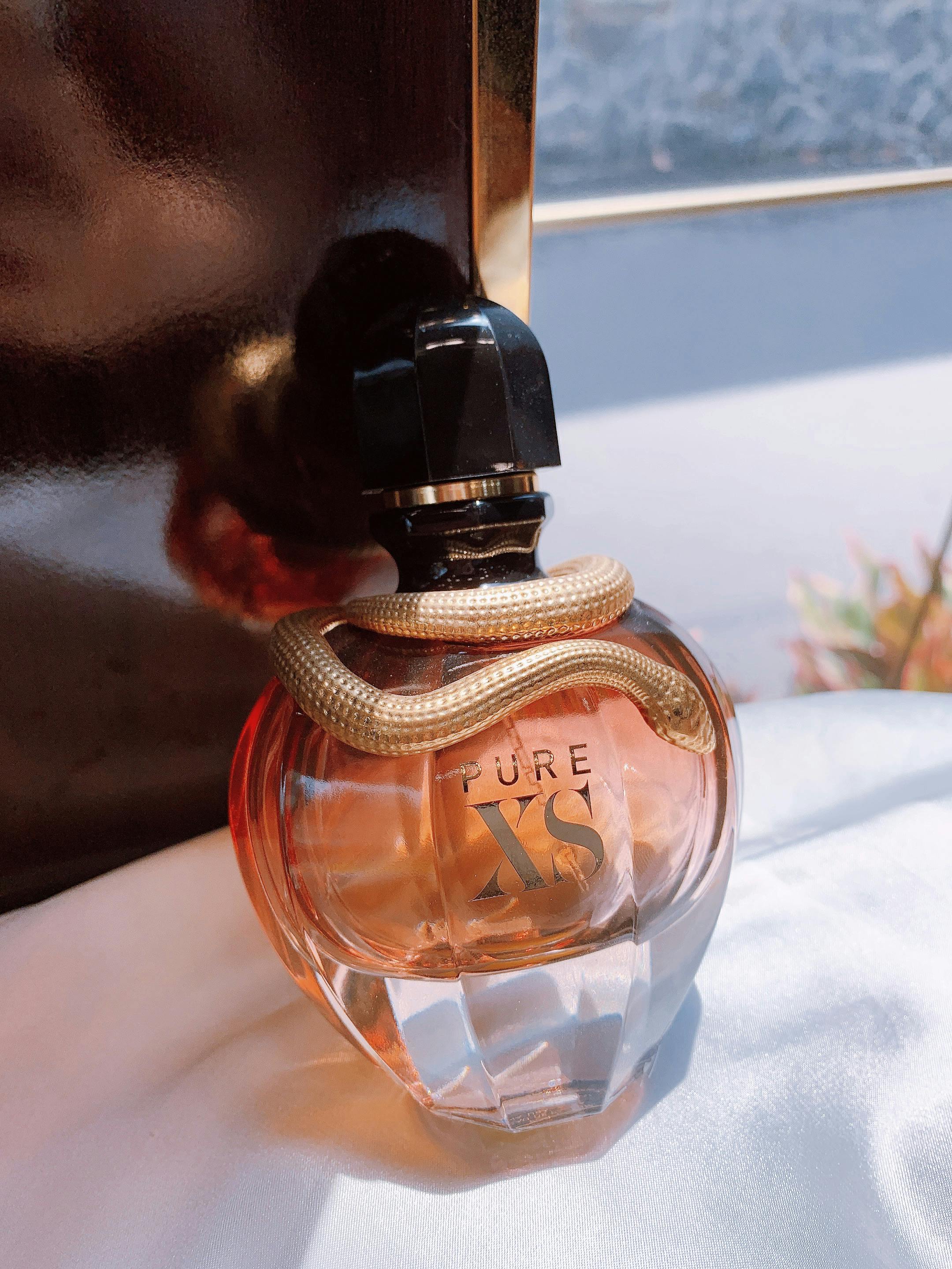 Pink Grass Bottle of Paco Rabanne Pure XS Eau De Parfum · Free Stock Photo