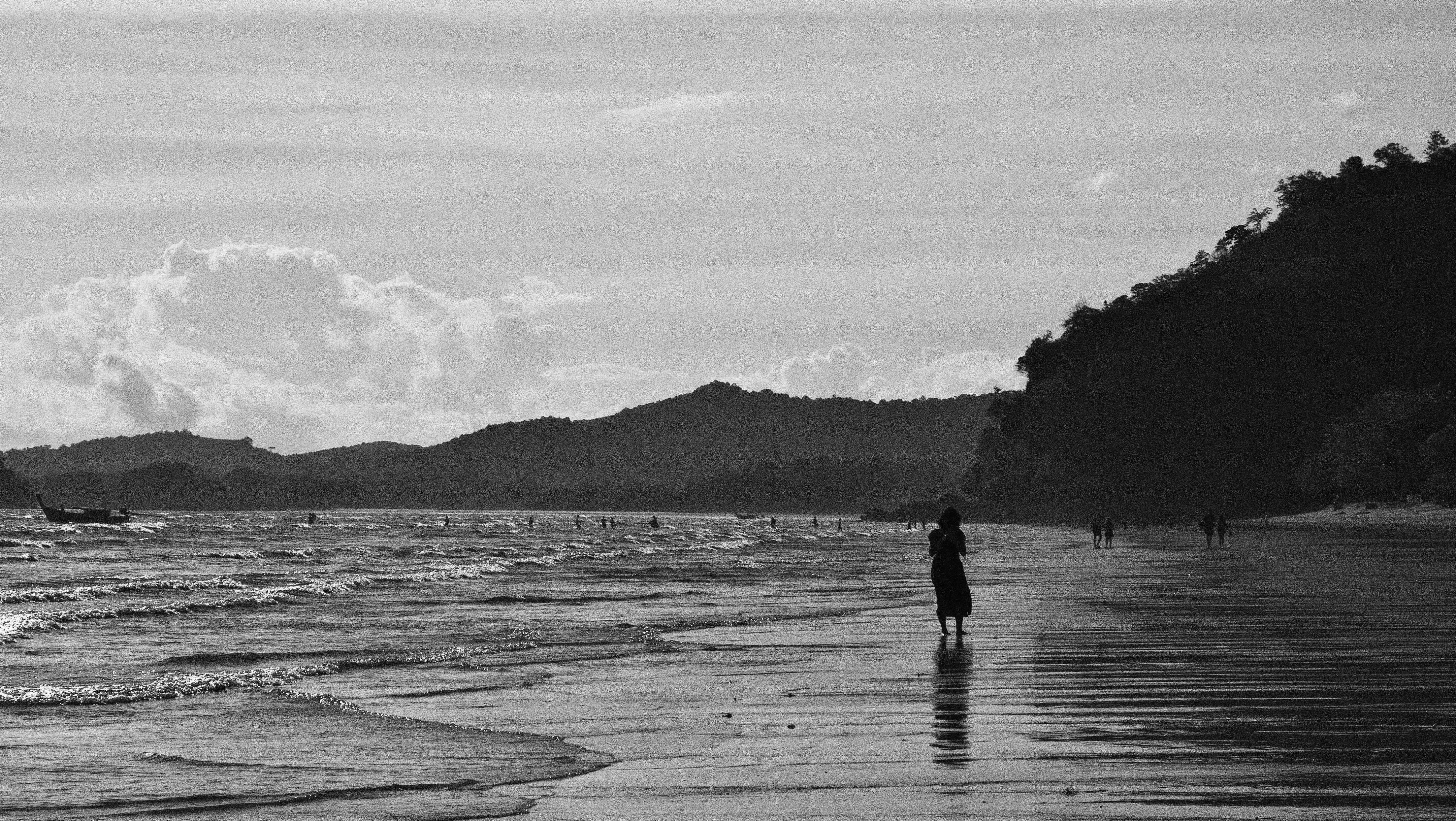 Grayscale Photo of People at a Beach · Free Stock Photo