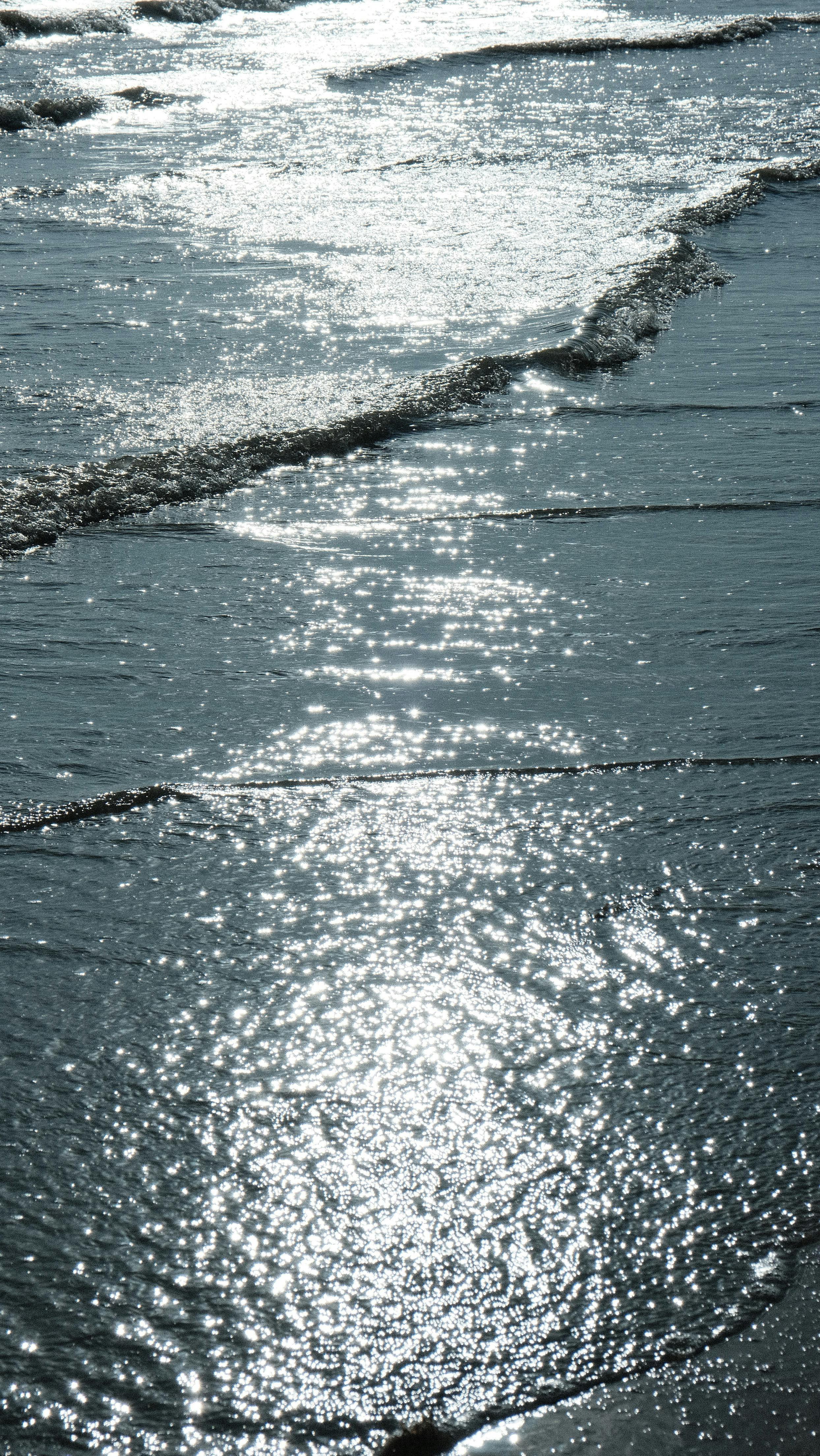 Sunlit Water on Shore · Free Stock Photo