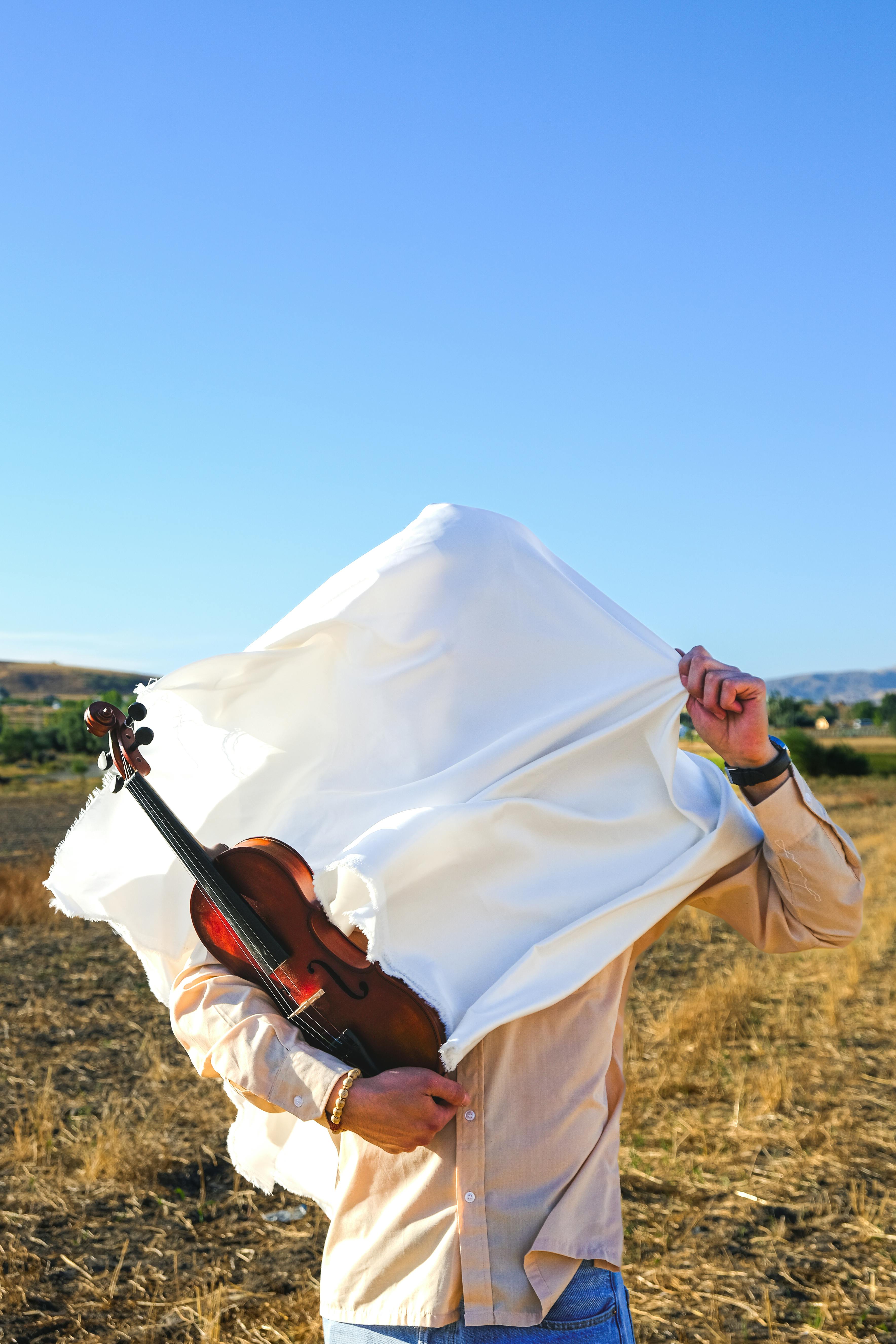 Musician with Violin and White Cloth on Head · Free Stock Photo