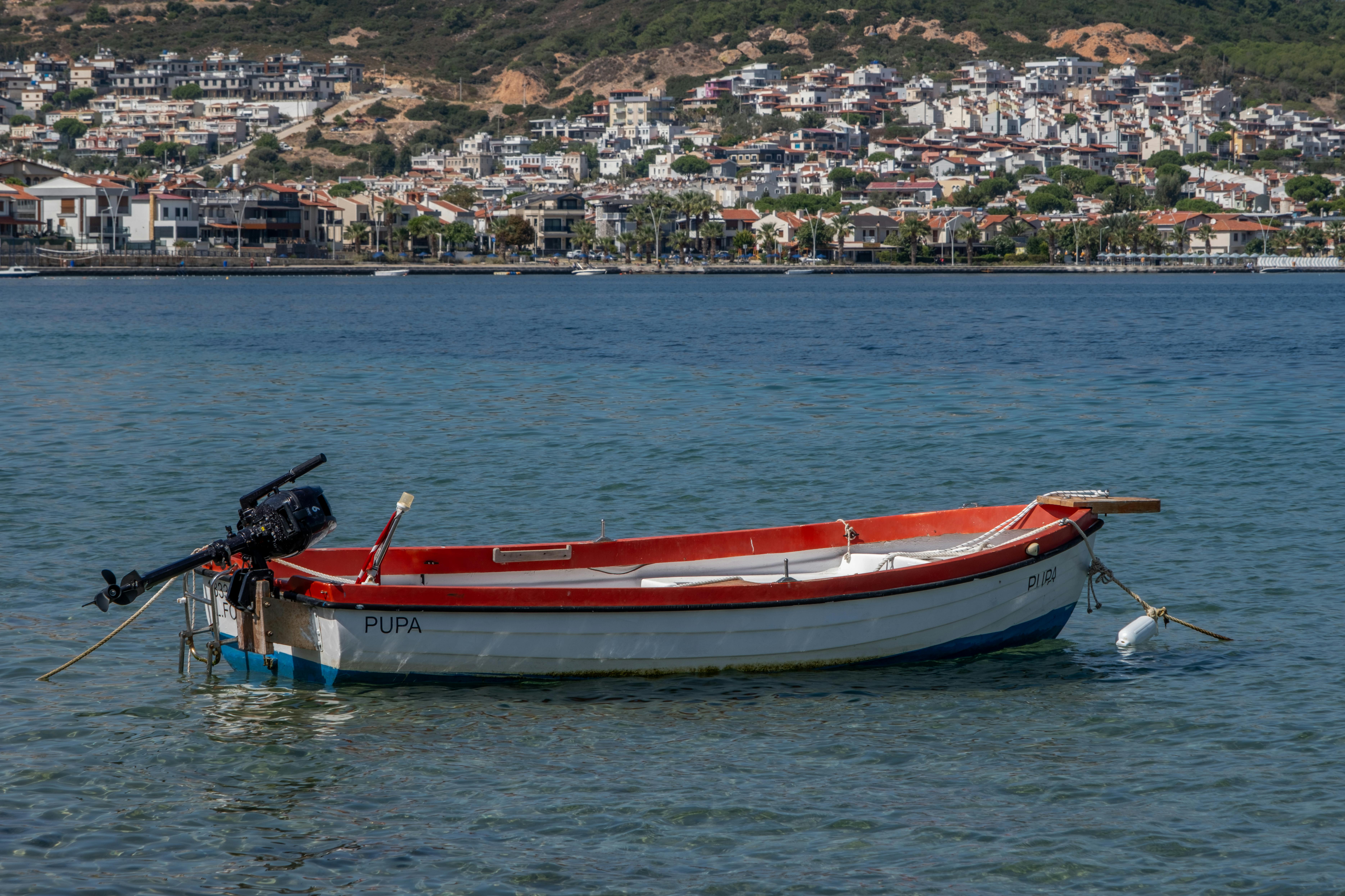 Empty Motorboat and Town on Coast behind · Free Stock Photo