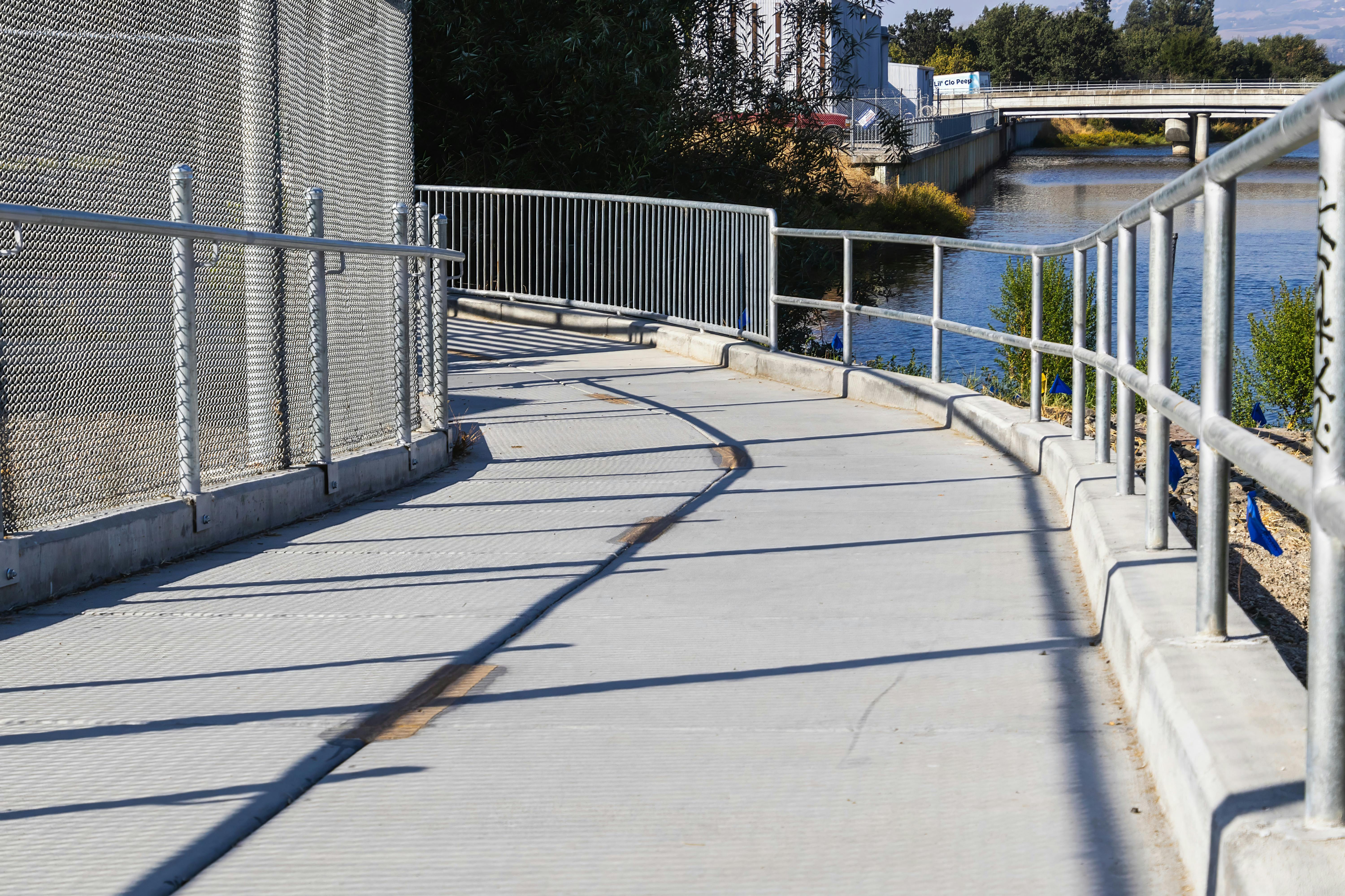 Pedestrian Bridge with Metal Railing and Mesh Fence · Free Stock Photo