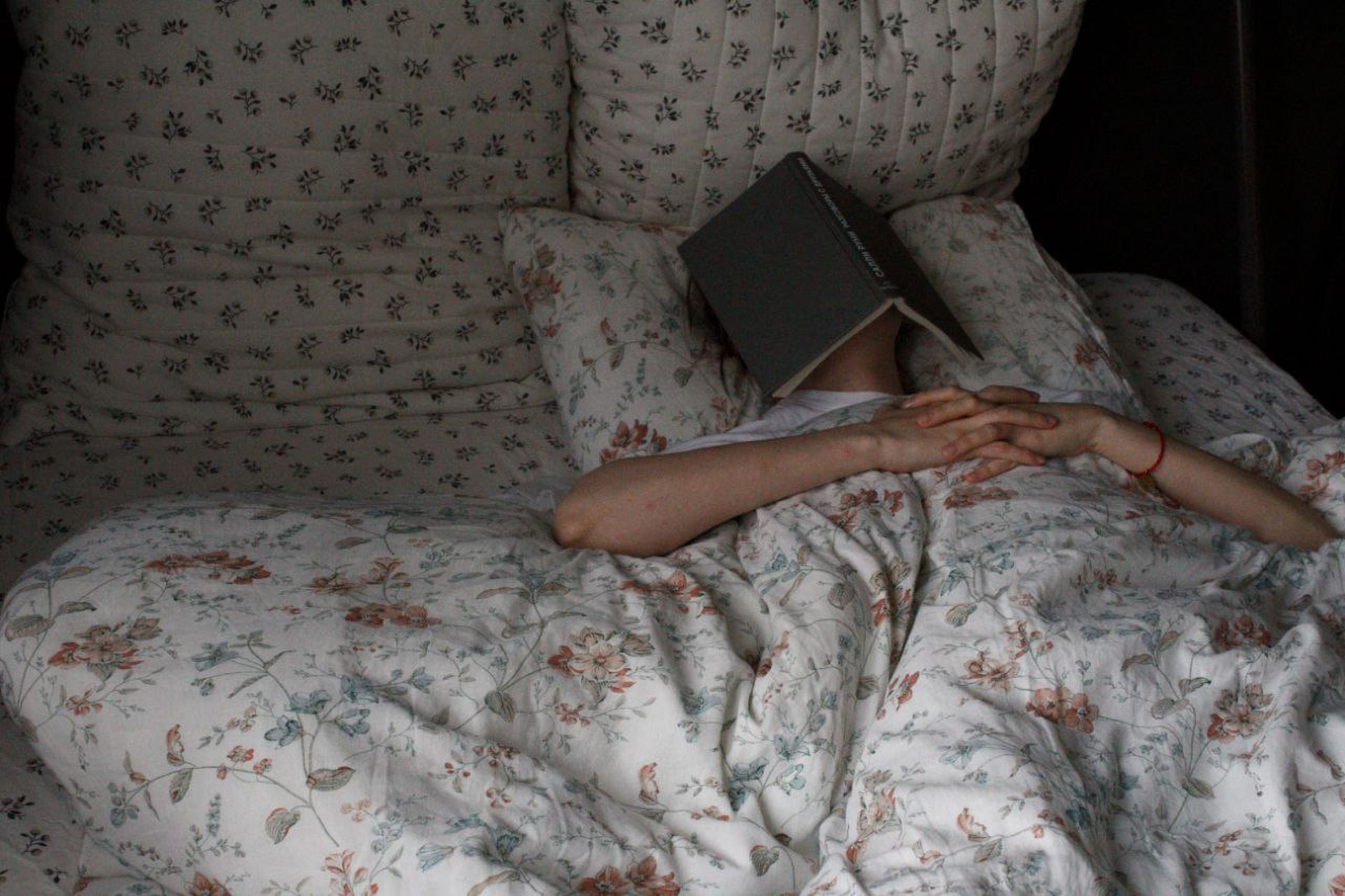 Person Sleeping in Bed with a Book on Her Face · Free Stock Photo