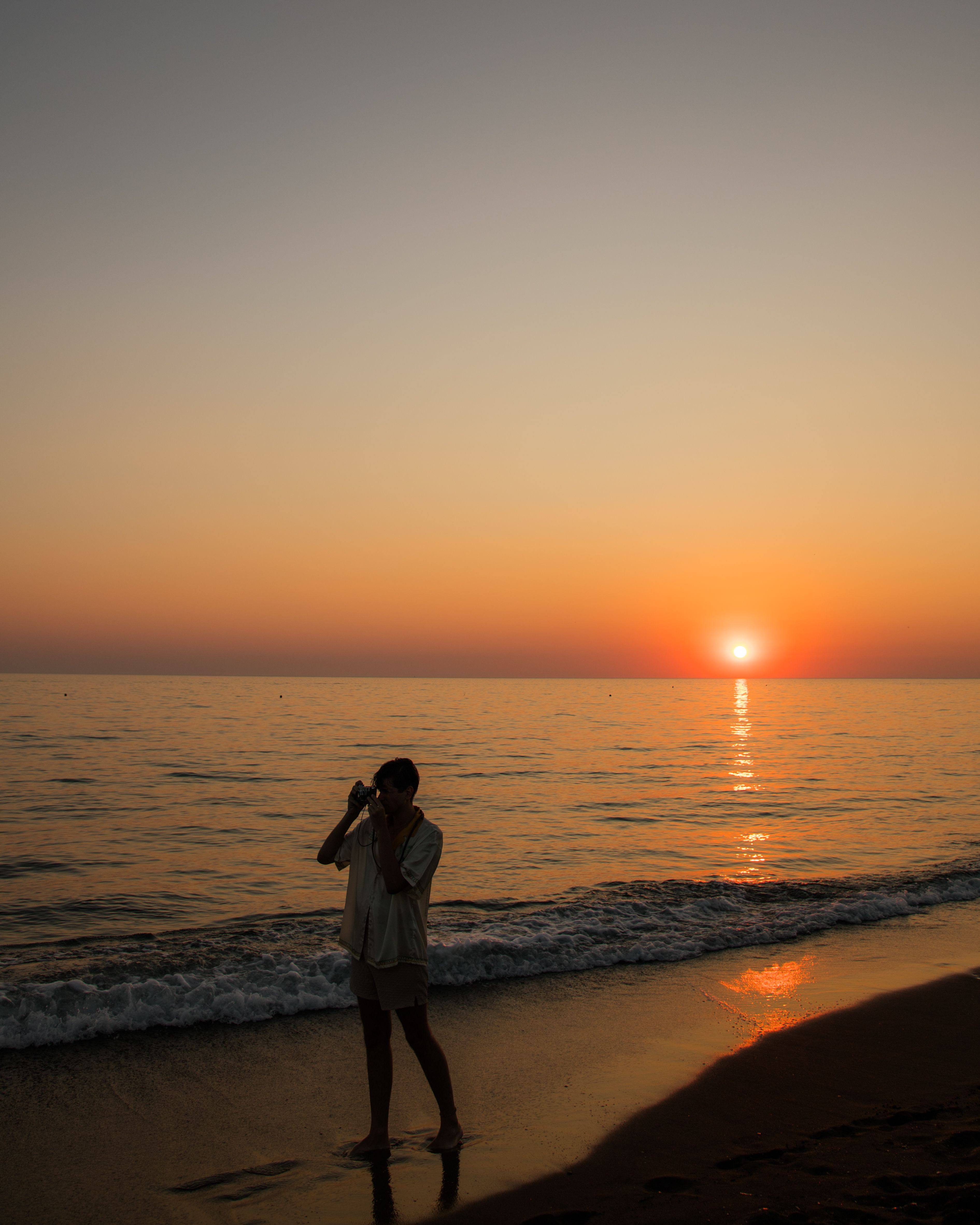 Man Standing on Beach at Sunset · Free Stock Photo