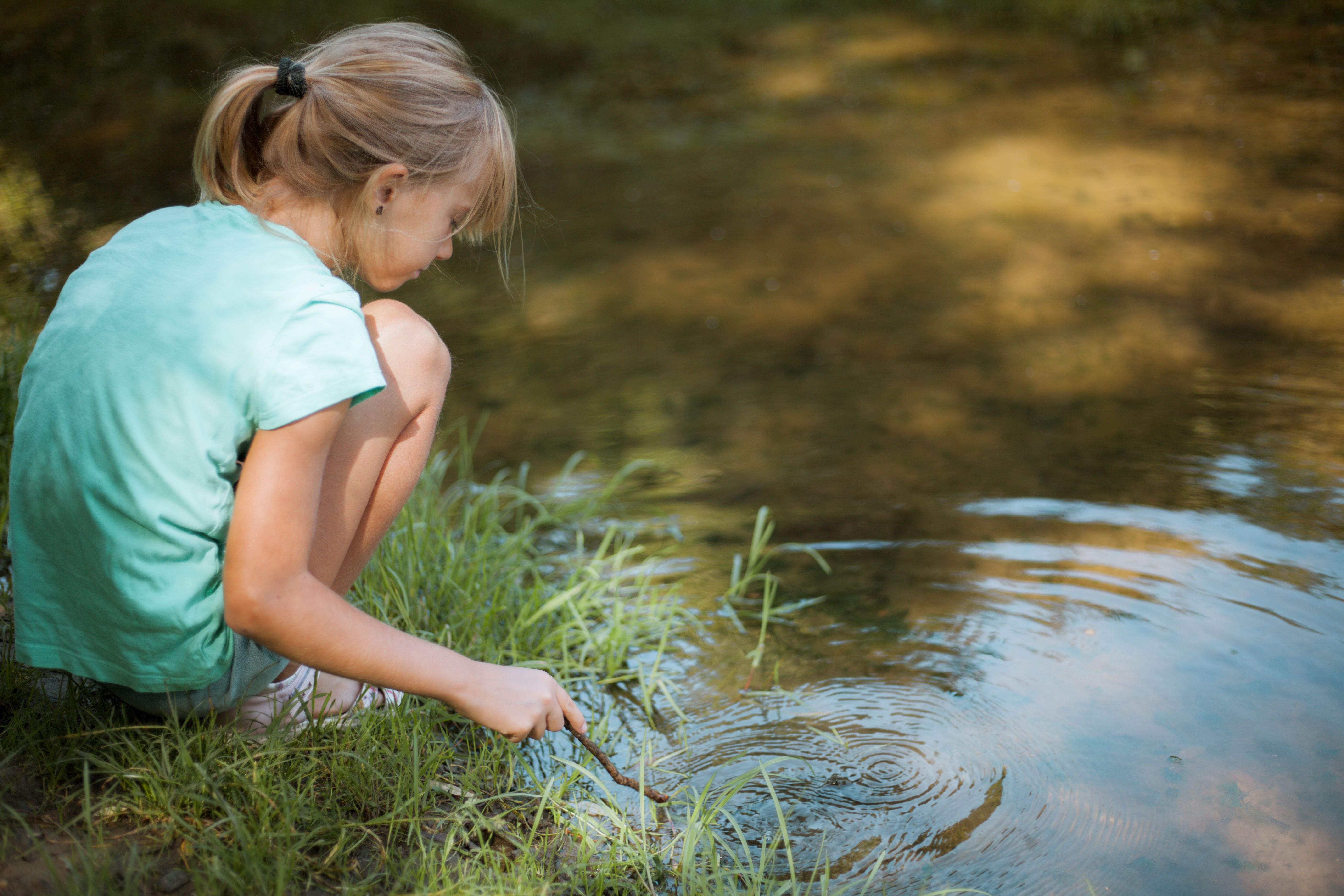 Girl Playing by a Stream · Free Stock Photo