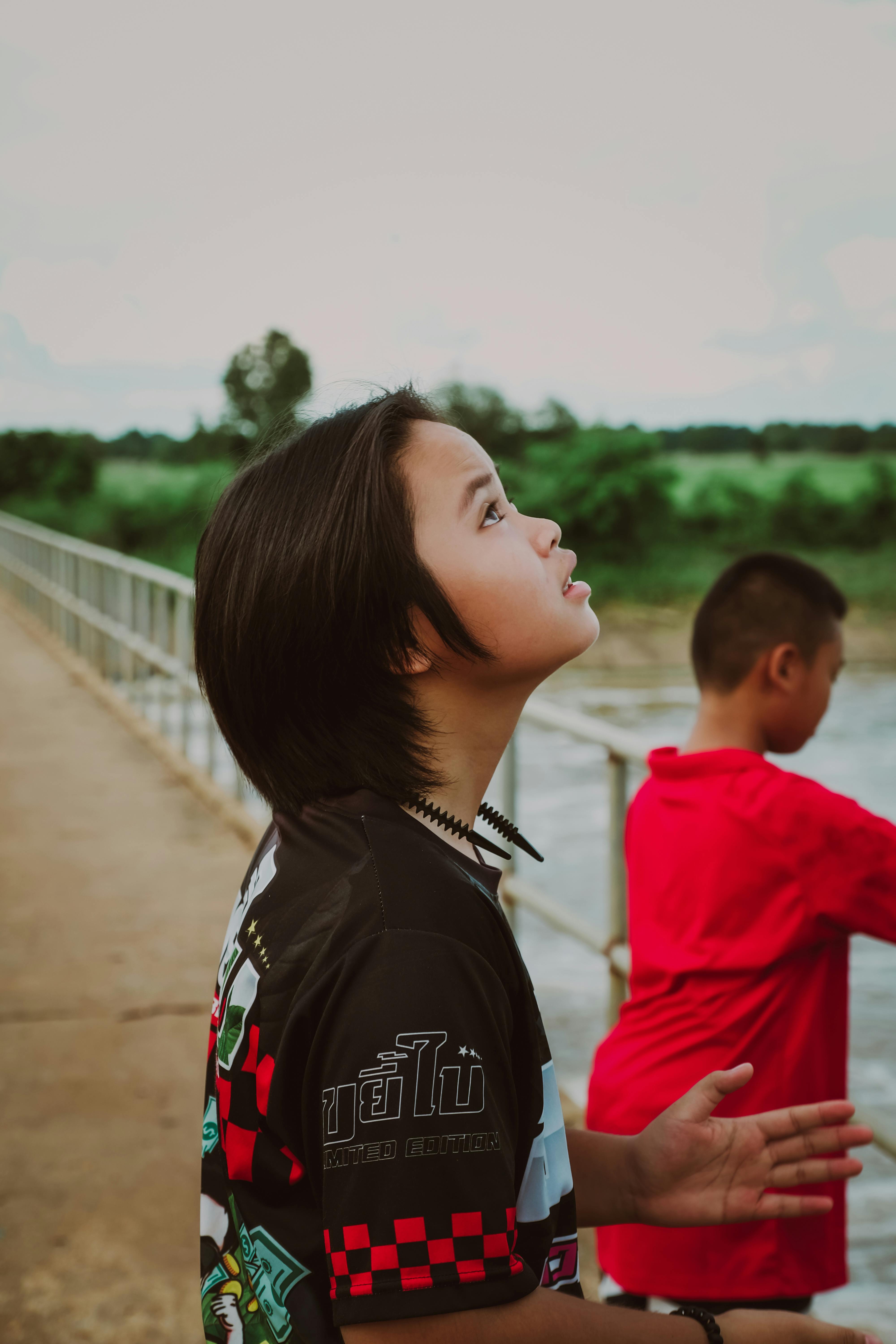 Boy and girl observing balls of newton s cradle moving · Free Stock Photo