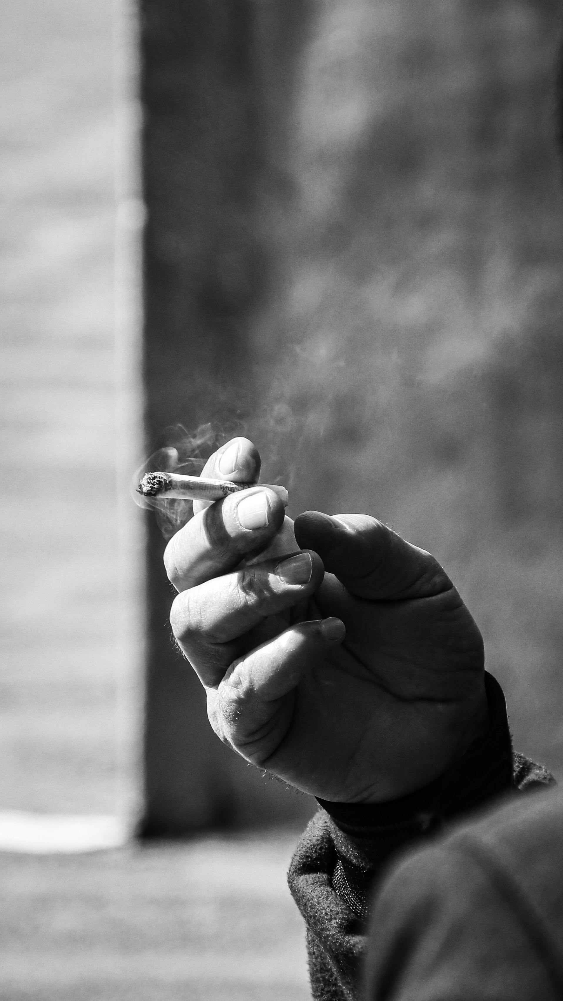 Close-Up Photography of a Person Holding Cigarette · Free Stock Photo