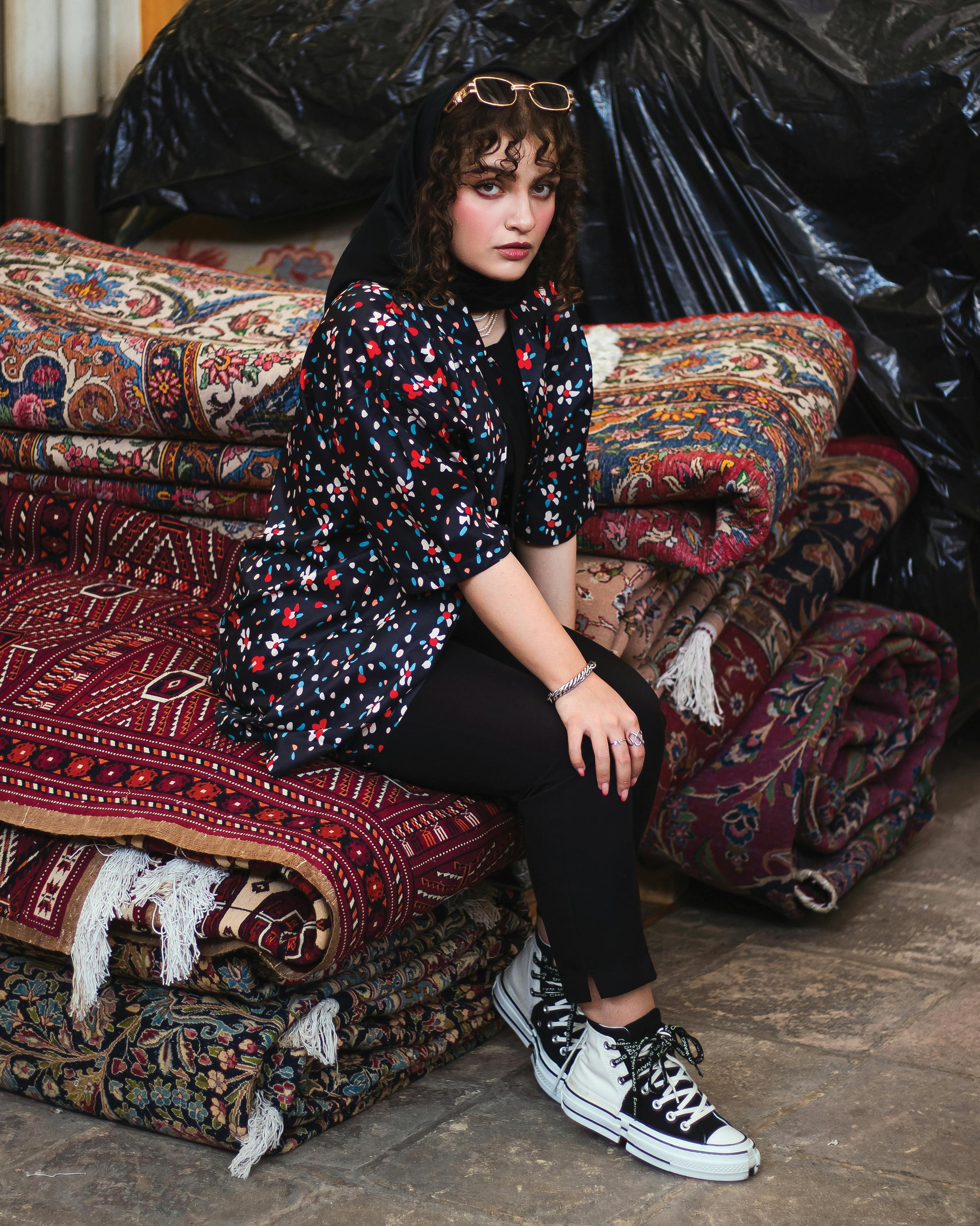Woman Sitting on Carpets and Posing · Free Stock Photo