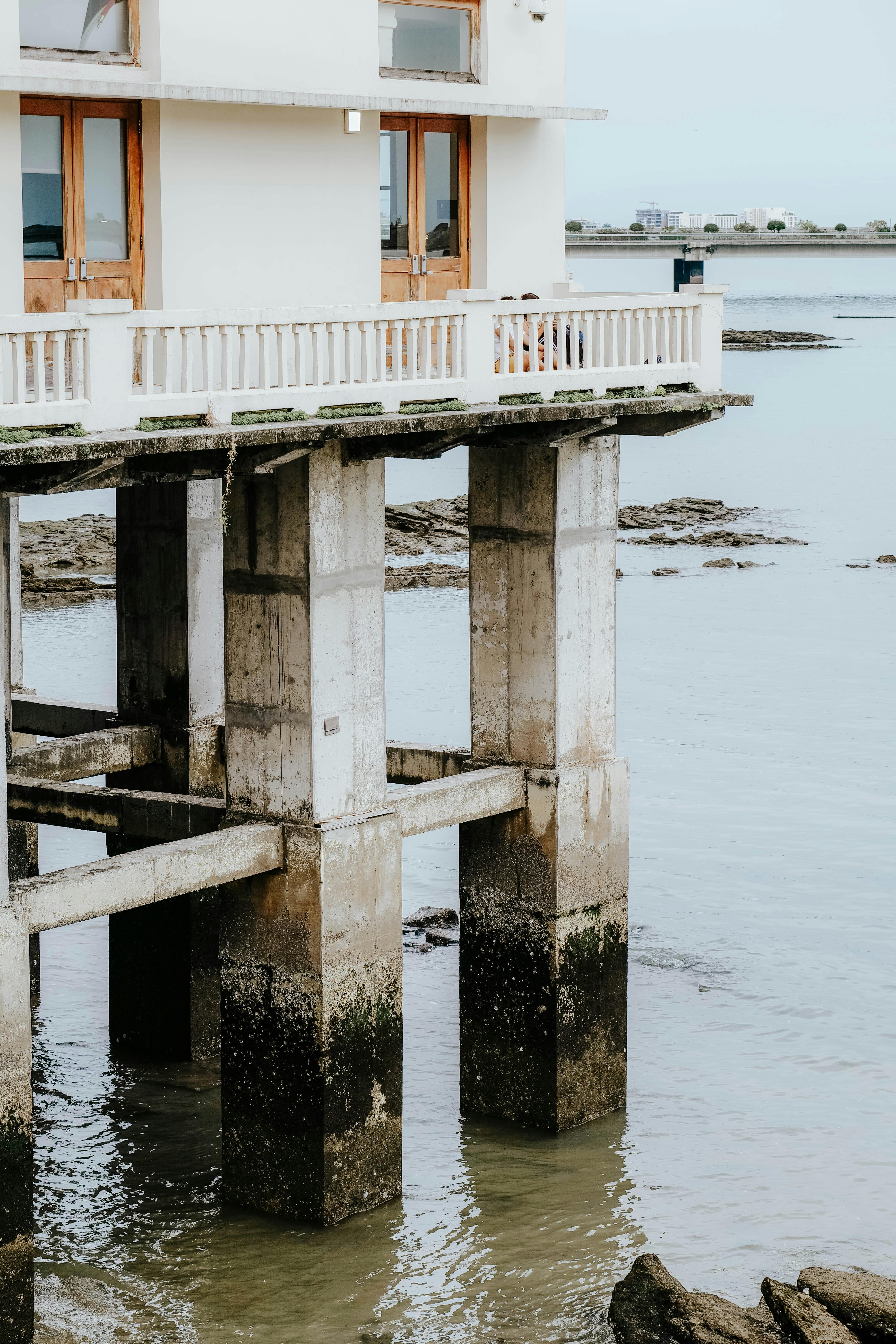 View of a Building on Concrete Stilts on a Shore · Free Stock Photo