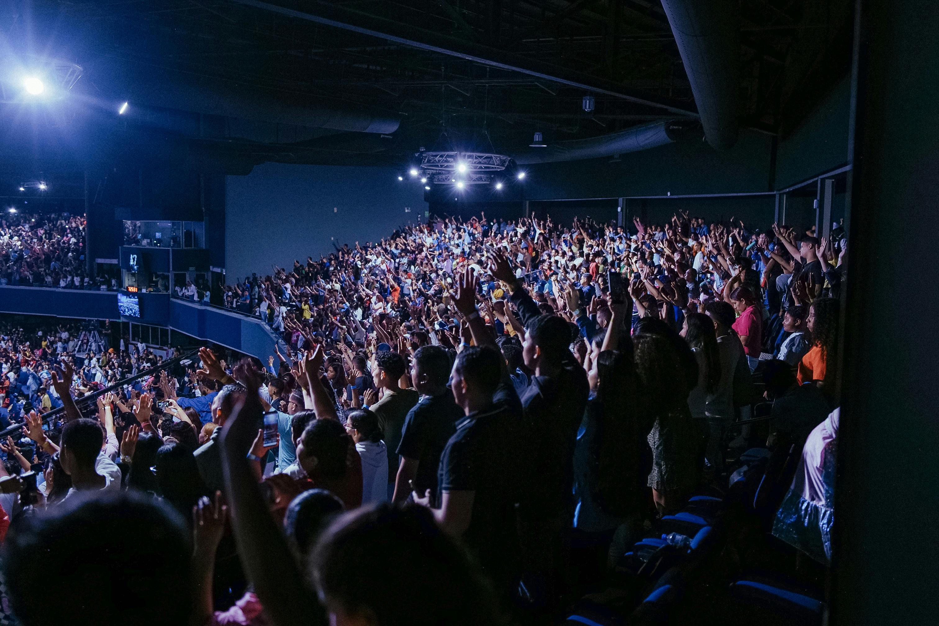 Audience Standing with Arms Raised · Free Stock Photo