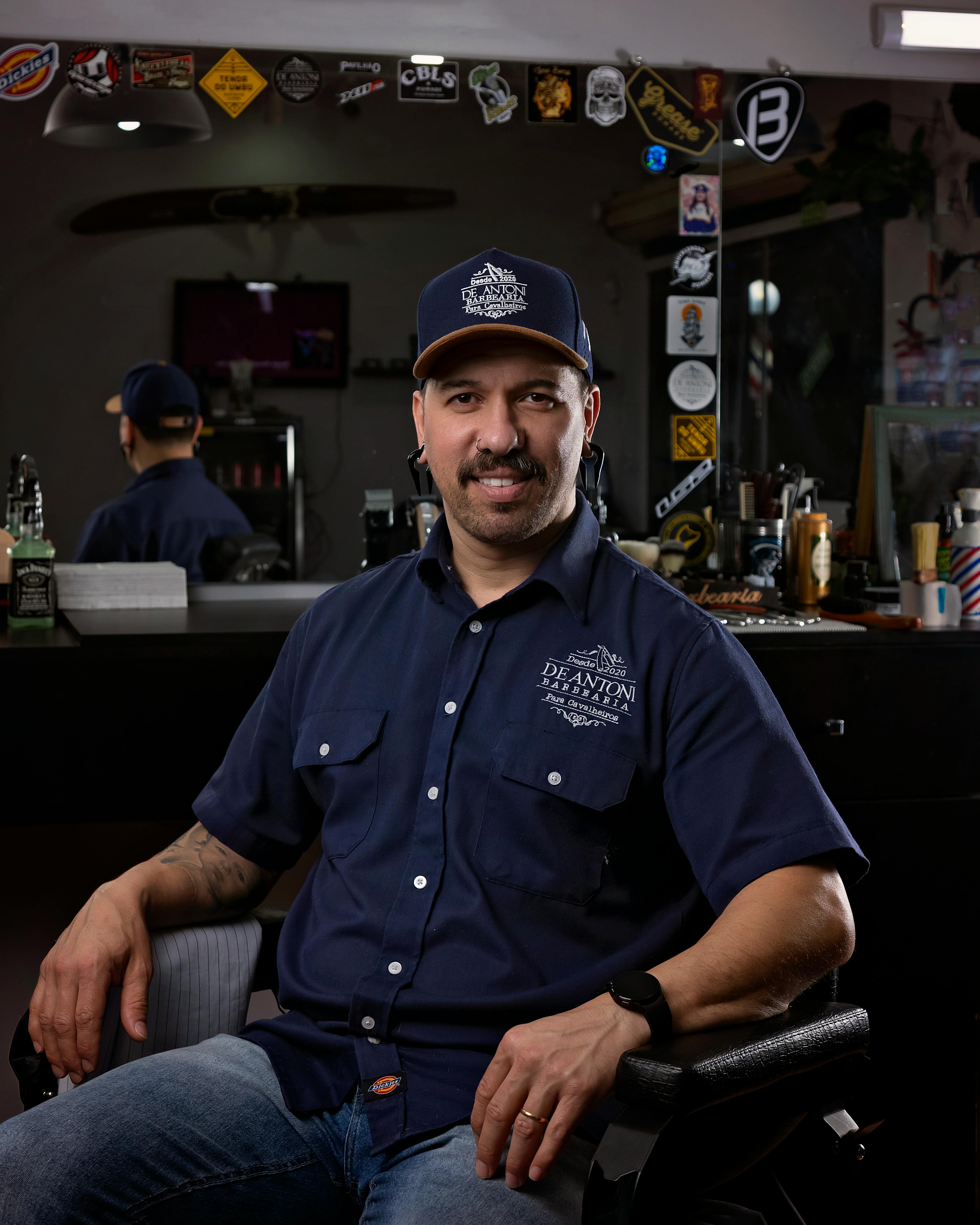 Man in a Baseball Cap Sitting in a Barber Shop · Free Stock Photo