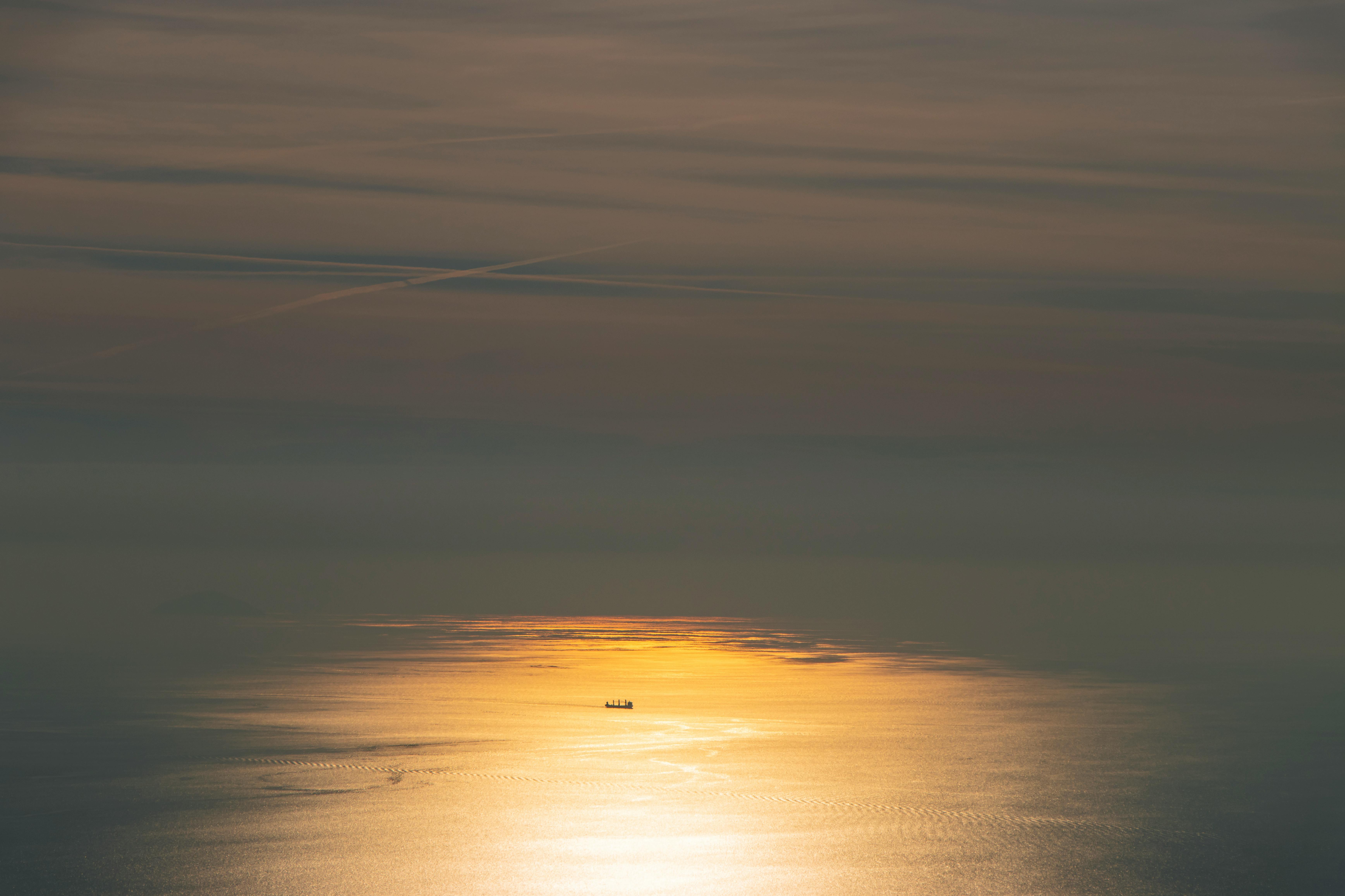 Single Ship on Shiny Sea at Sunset · Free Stock Photo