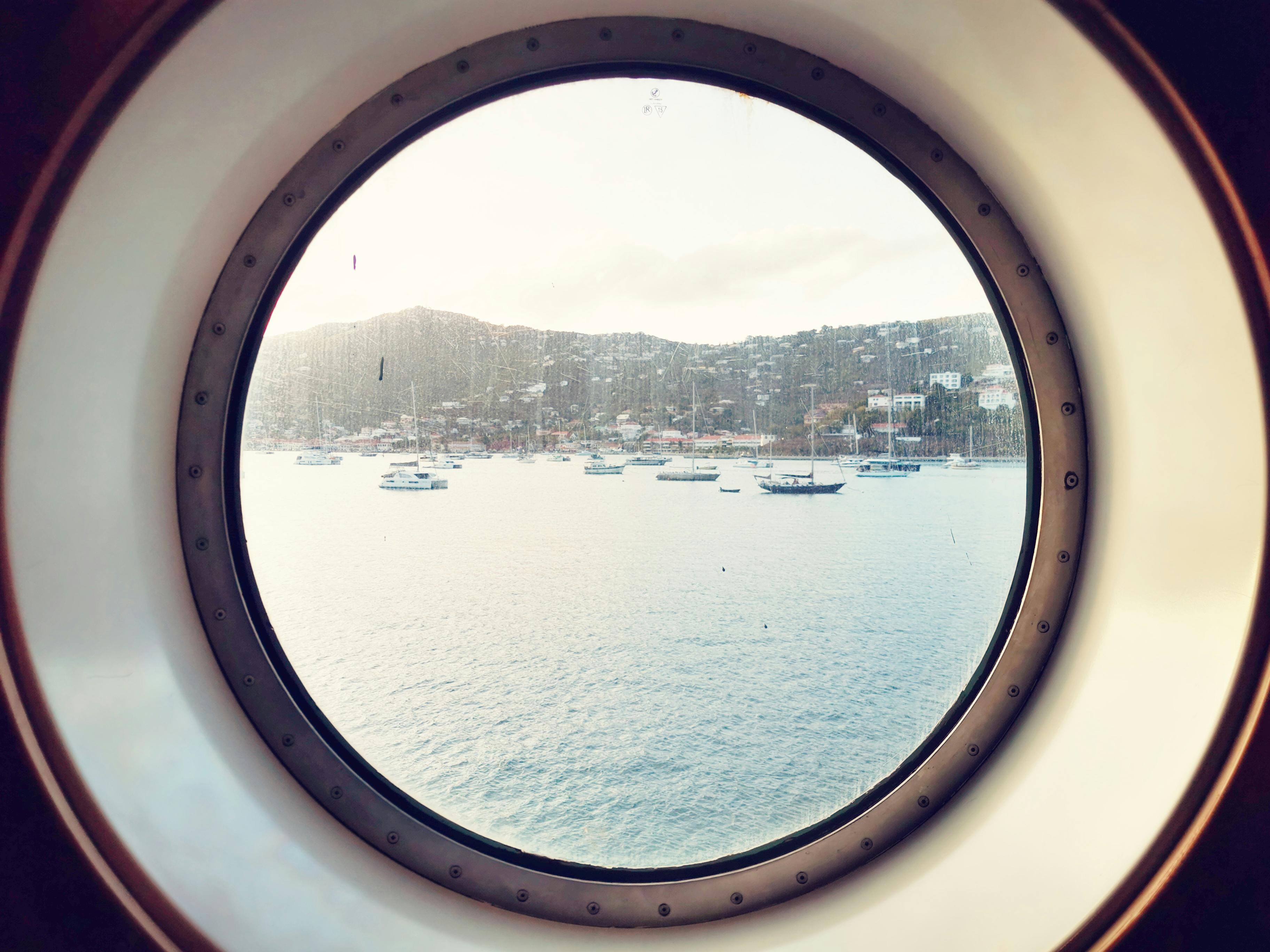 Yachts and Sea Coast behind Ship Window · Free Stock Photo