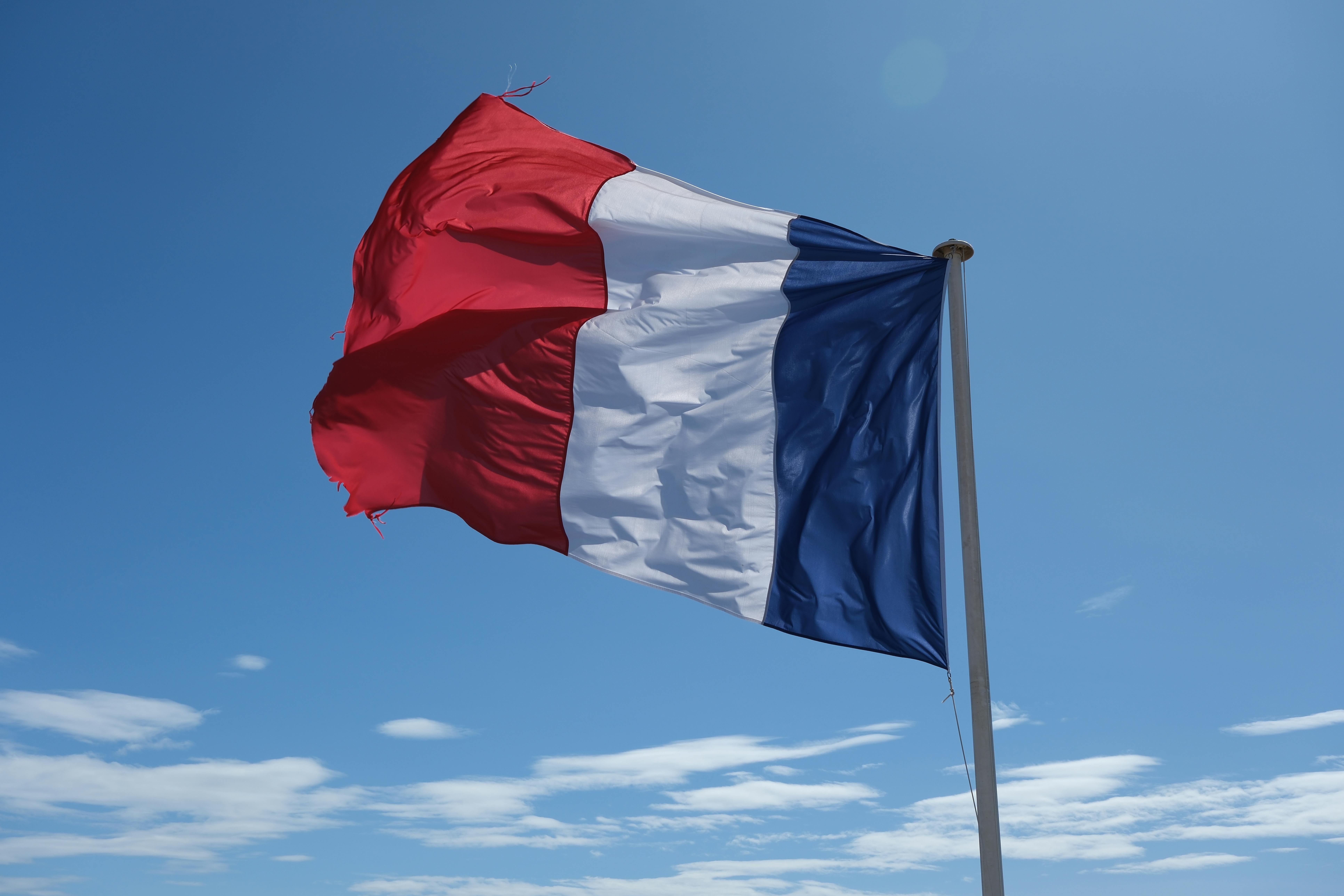 French Flag Blowing in the Wind · Free Stock Photo