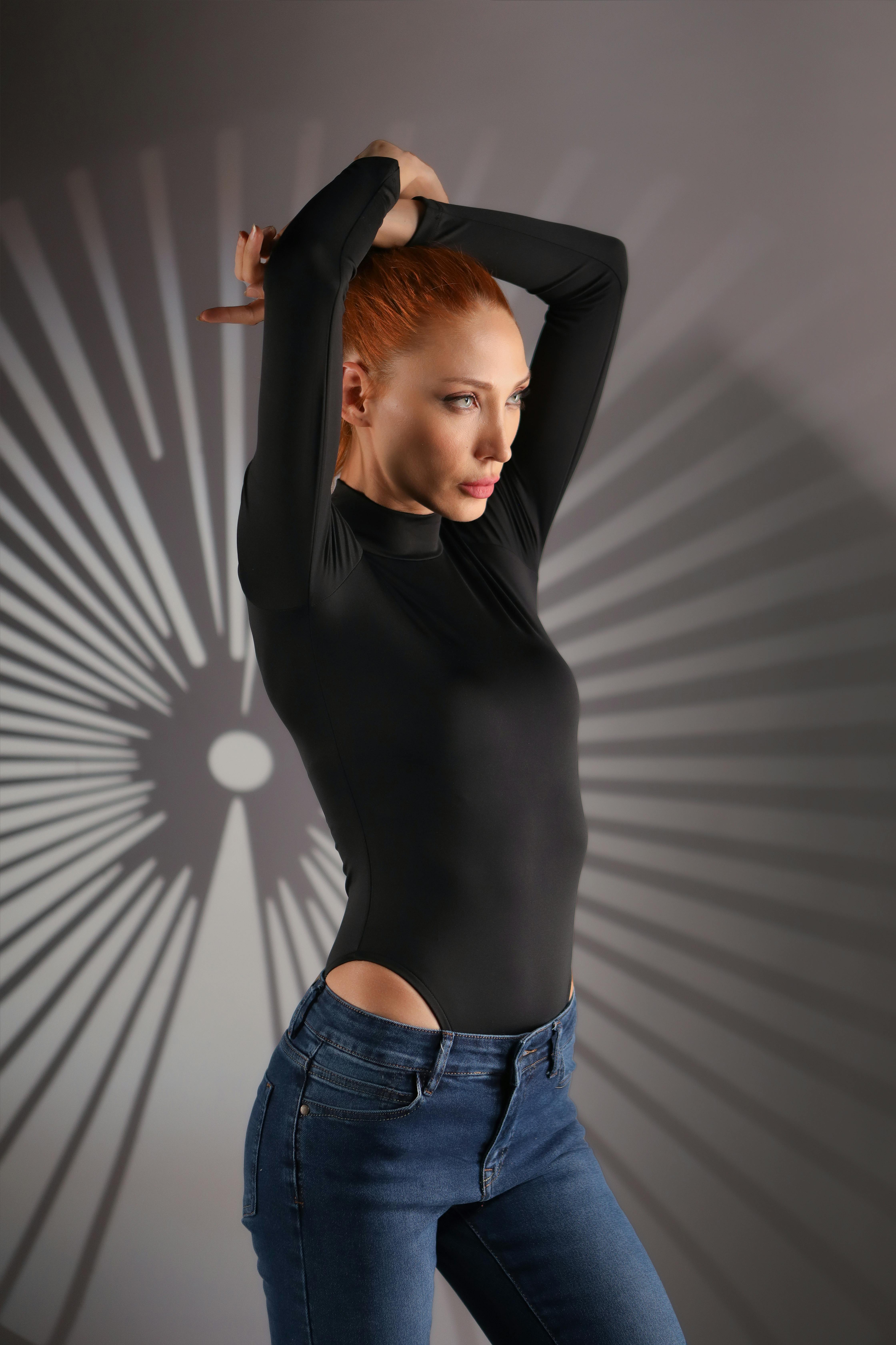 Woman Standing with Arms Raised · Free Stock Photo