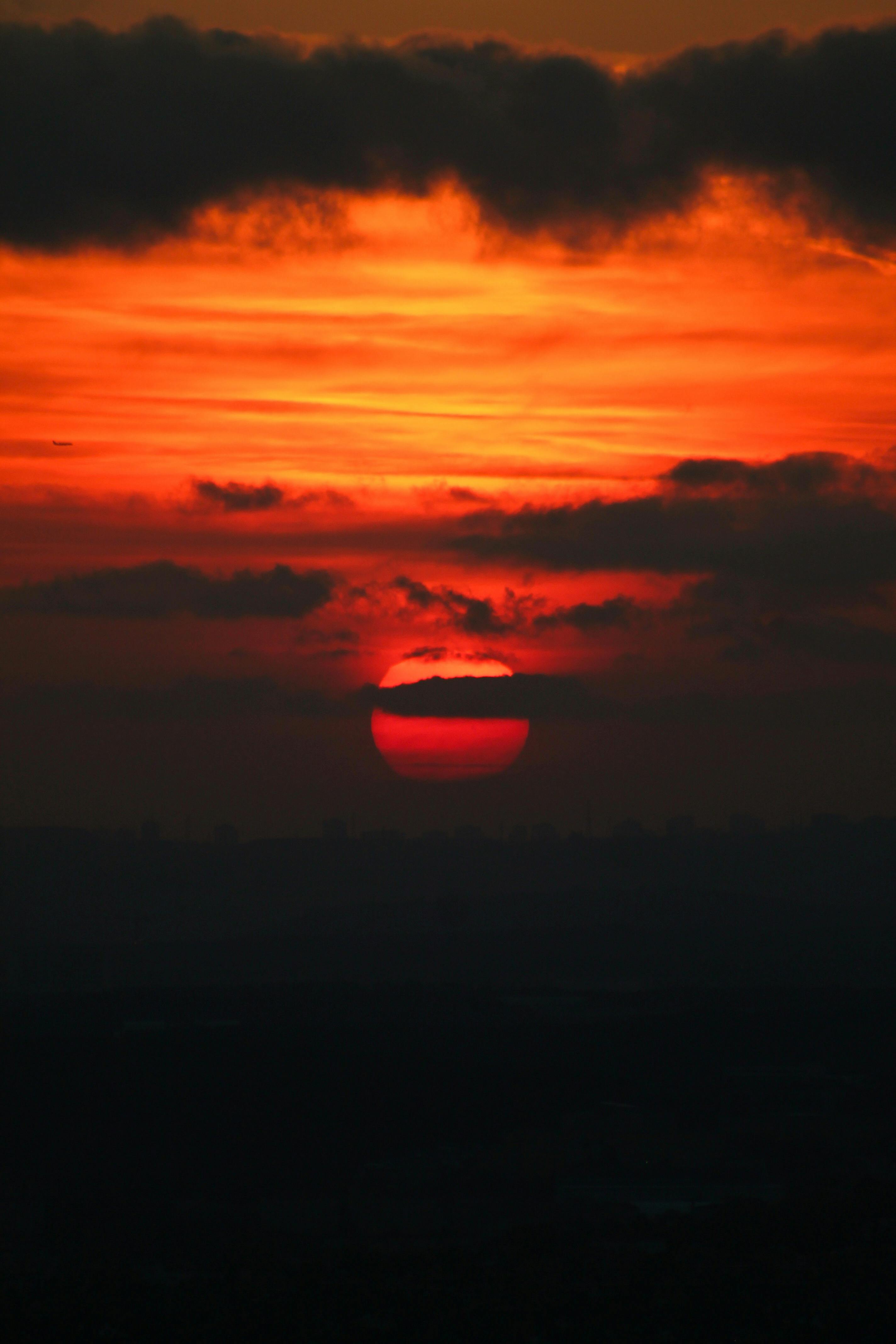 Clouds Backlit by the Red Setting Sun · Free Stock Photo