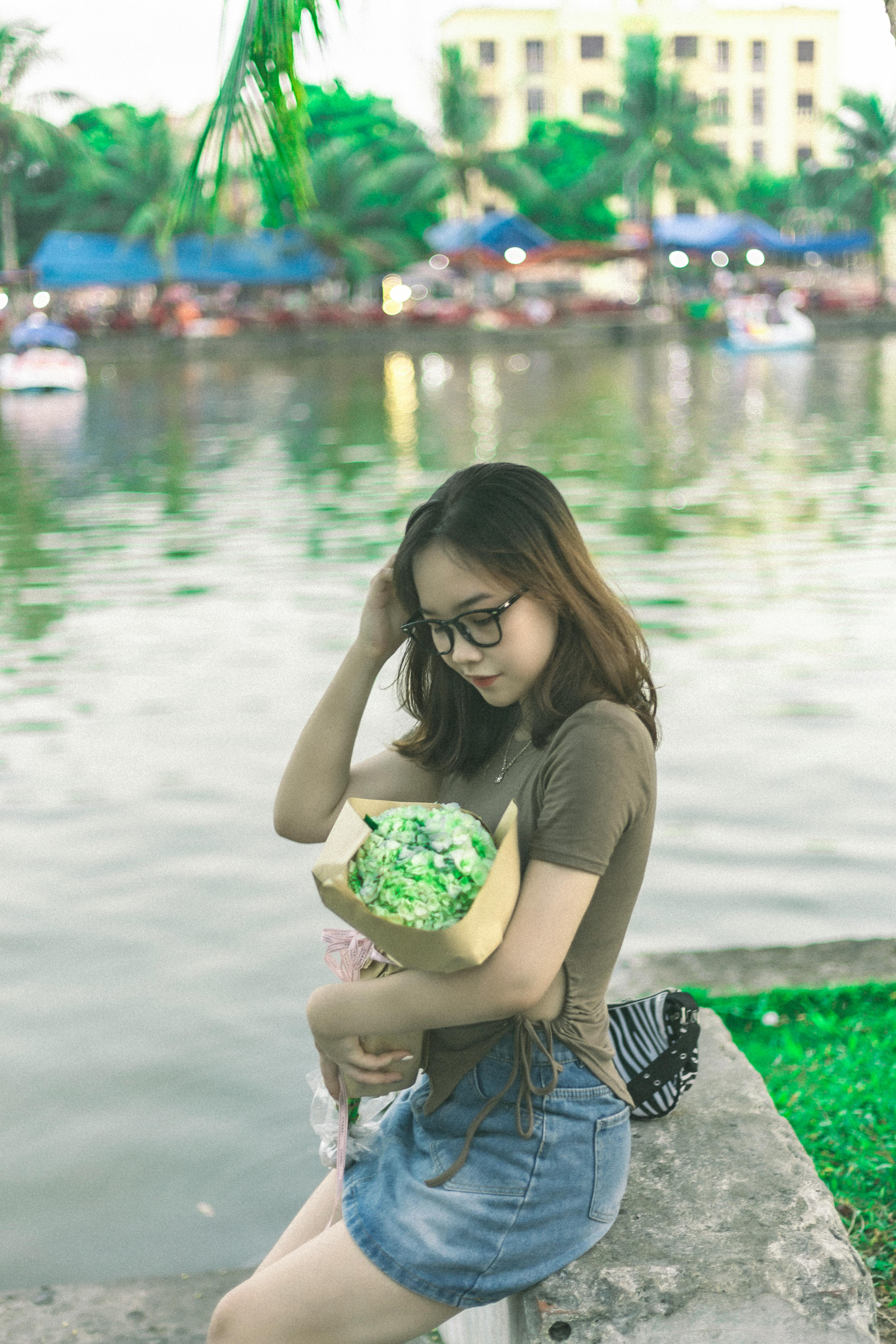 Young Woman in a Blouse with Side Strings and a Denim Mini Skirt ...